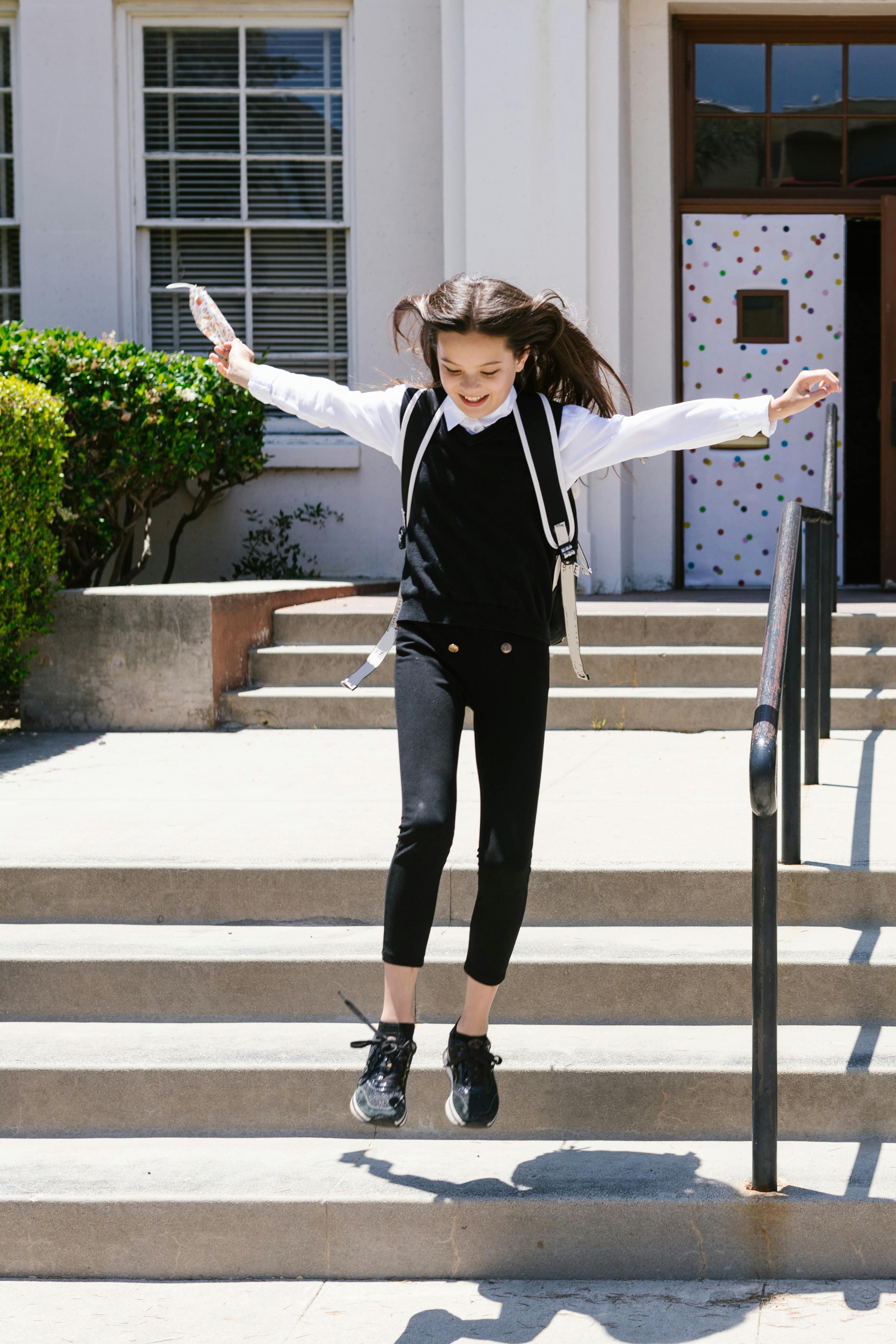 A Girl Jumping on the Stairs · Free Stock Photo