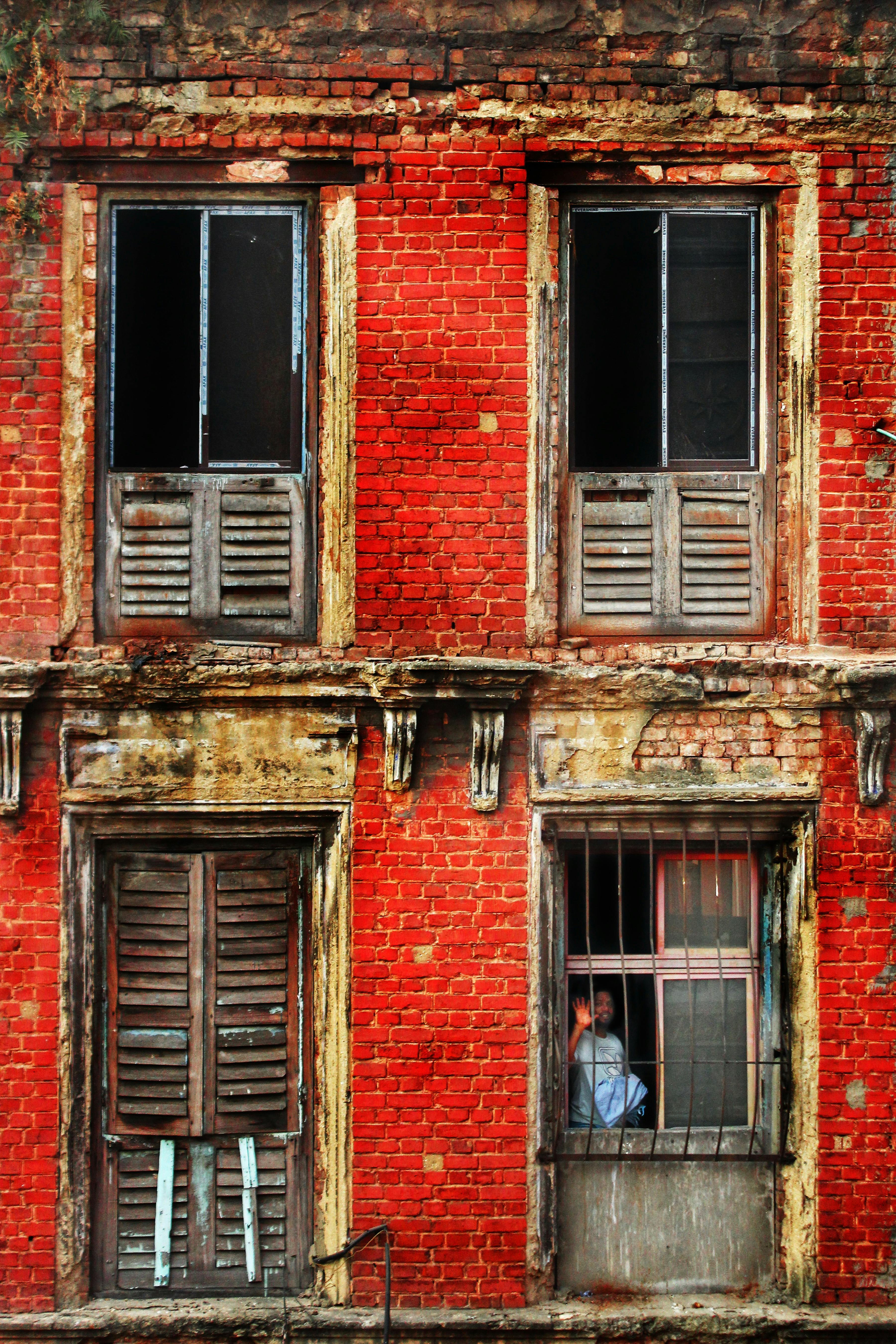 Man Inside the Broken Brick Building · Free Stock Photo
