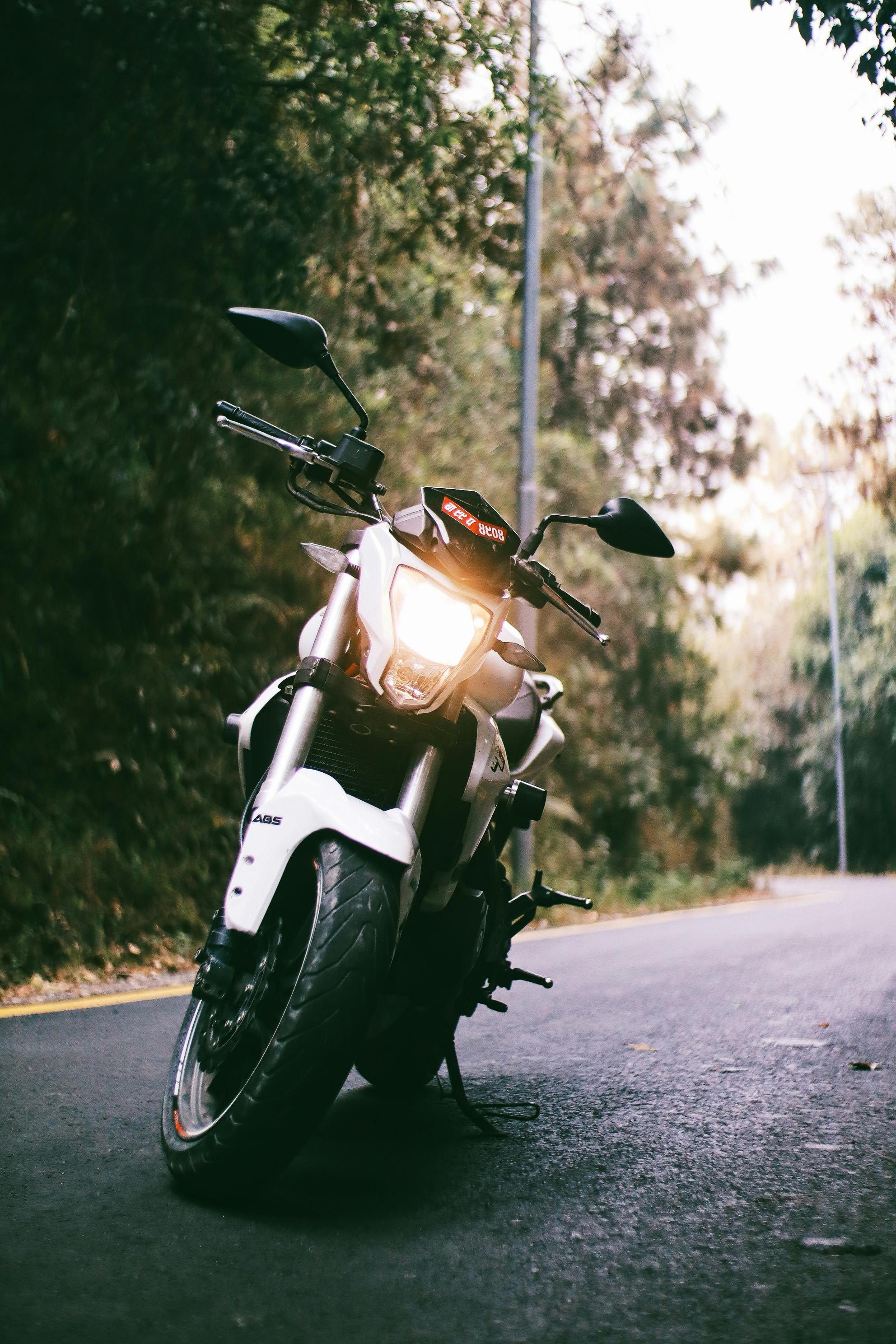 White Motorcycle Parked on Gray Concrete Road · Free Stock Photo
