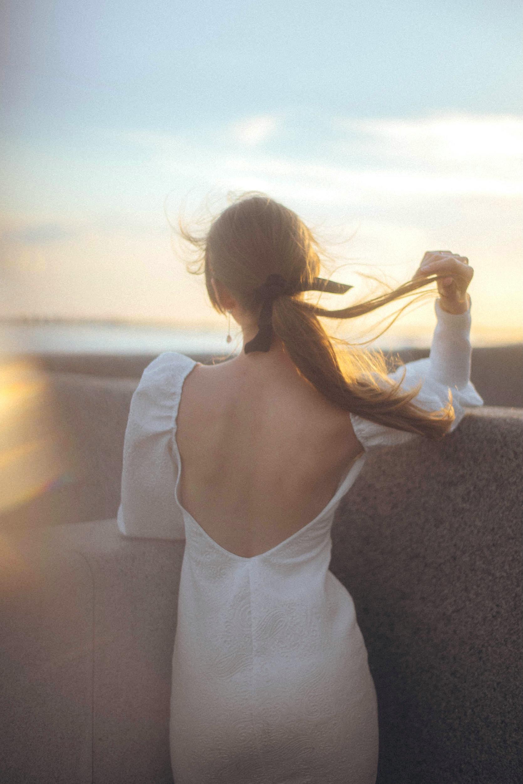 A Woman Wearing a Backless White Dress · Free Stock Photo