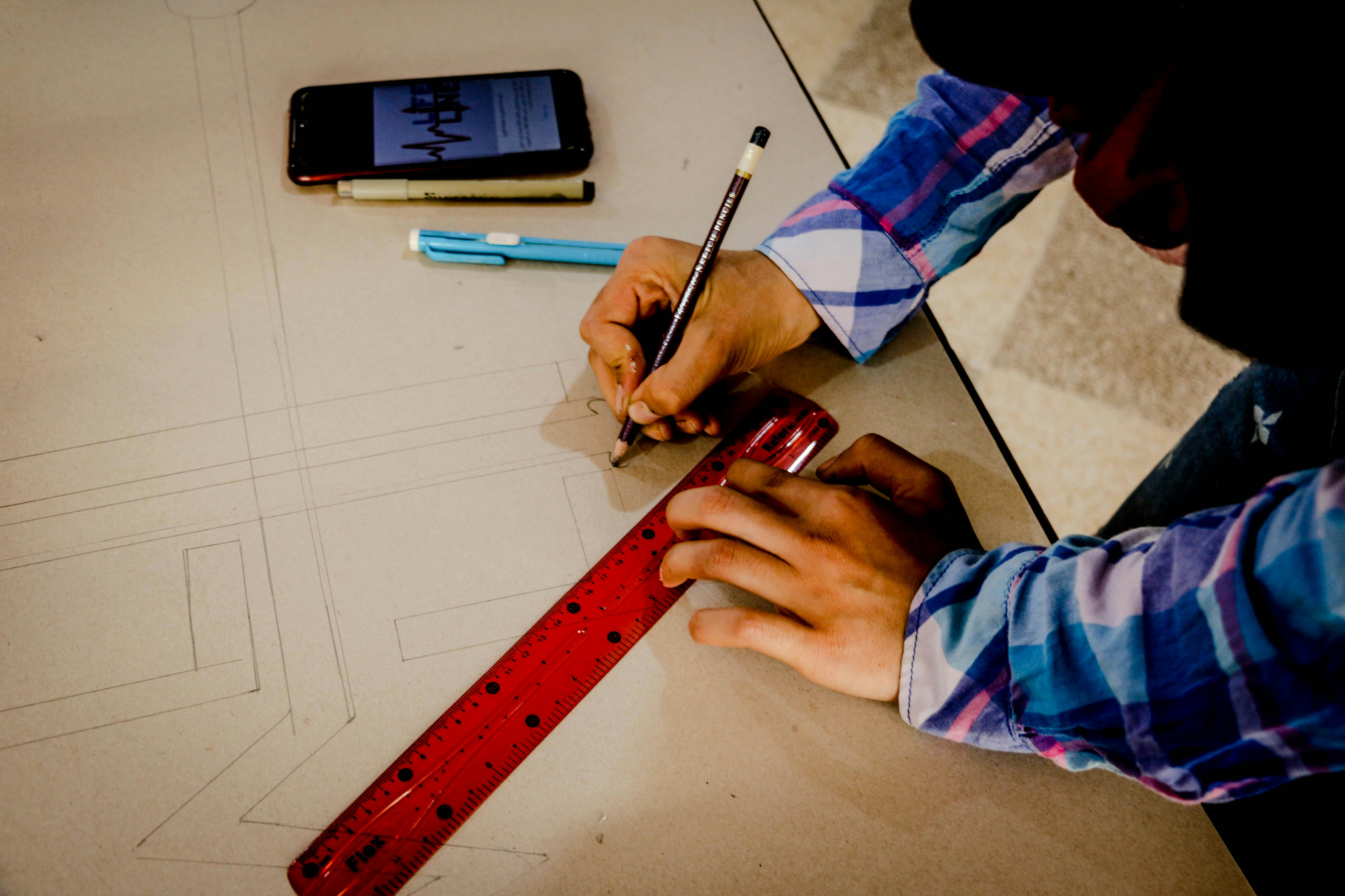 Drawing with Ruler on Cardboard · Free Stock Photo