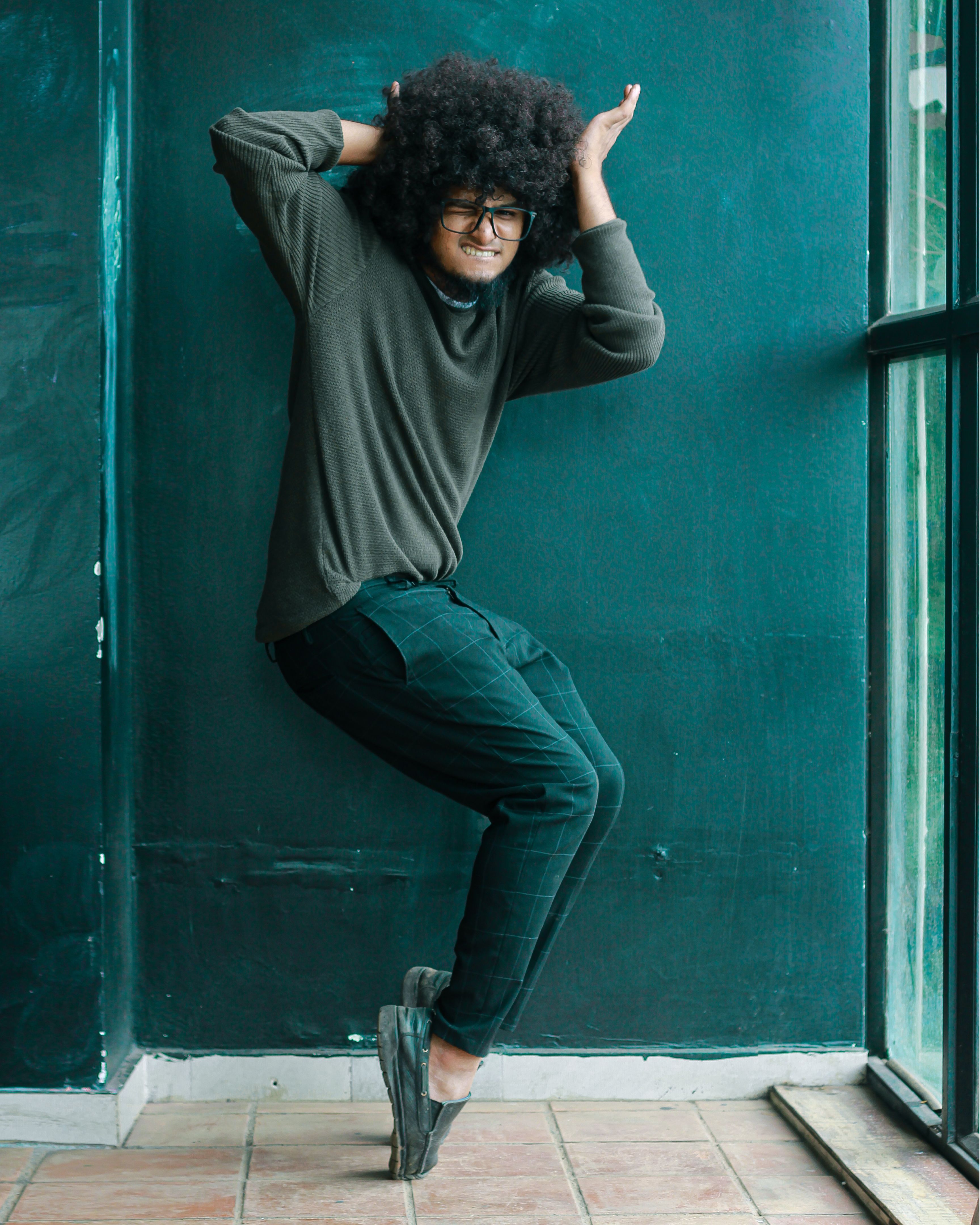 Young Man Standing on His Tiptoes and Making a Facial Expression · Free ...