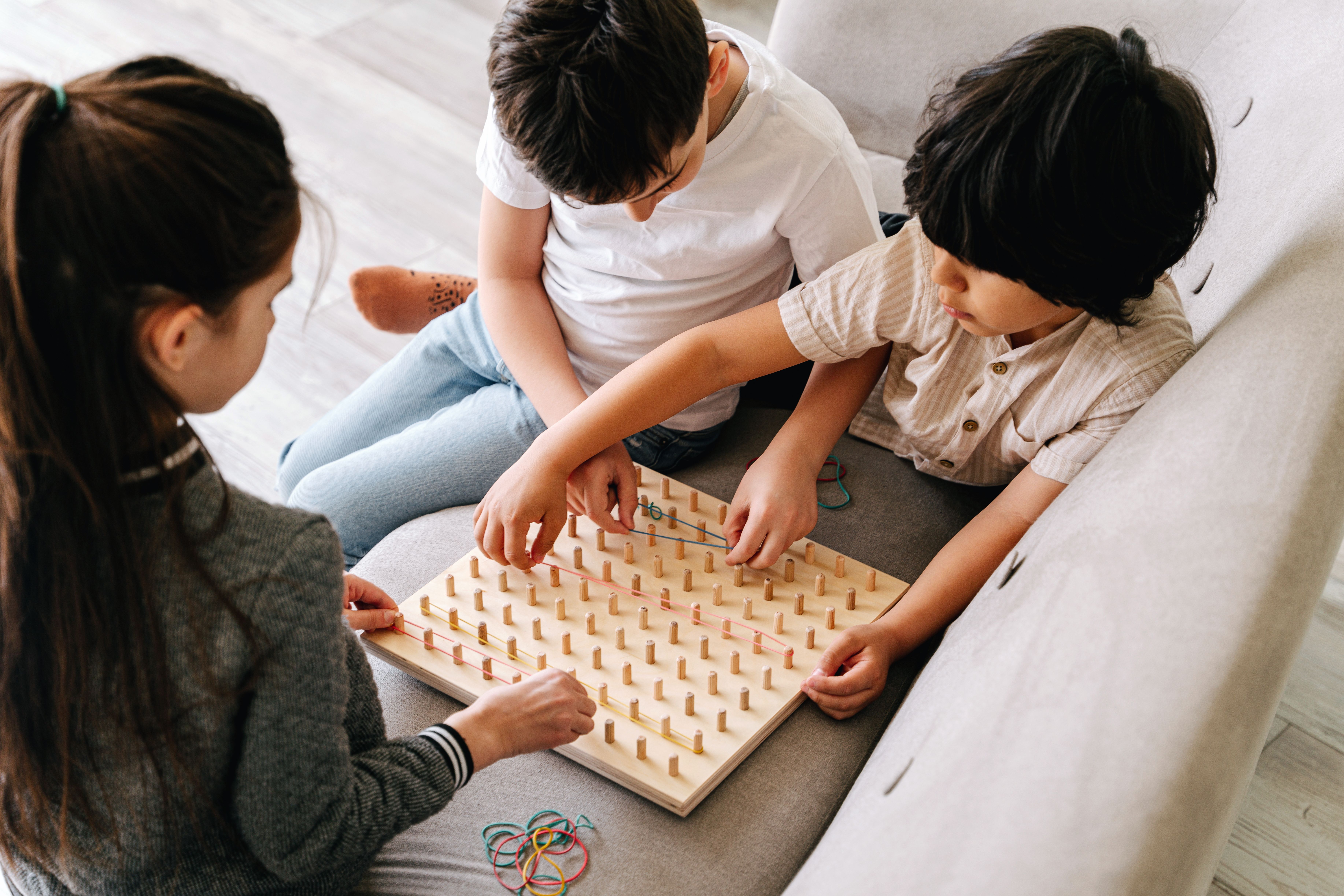 High-Angle Shot of Kids Playing Geoboard · Free Stock Photo