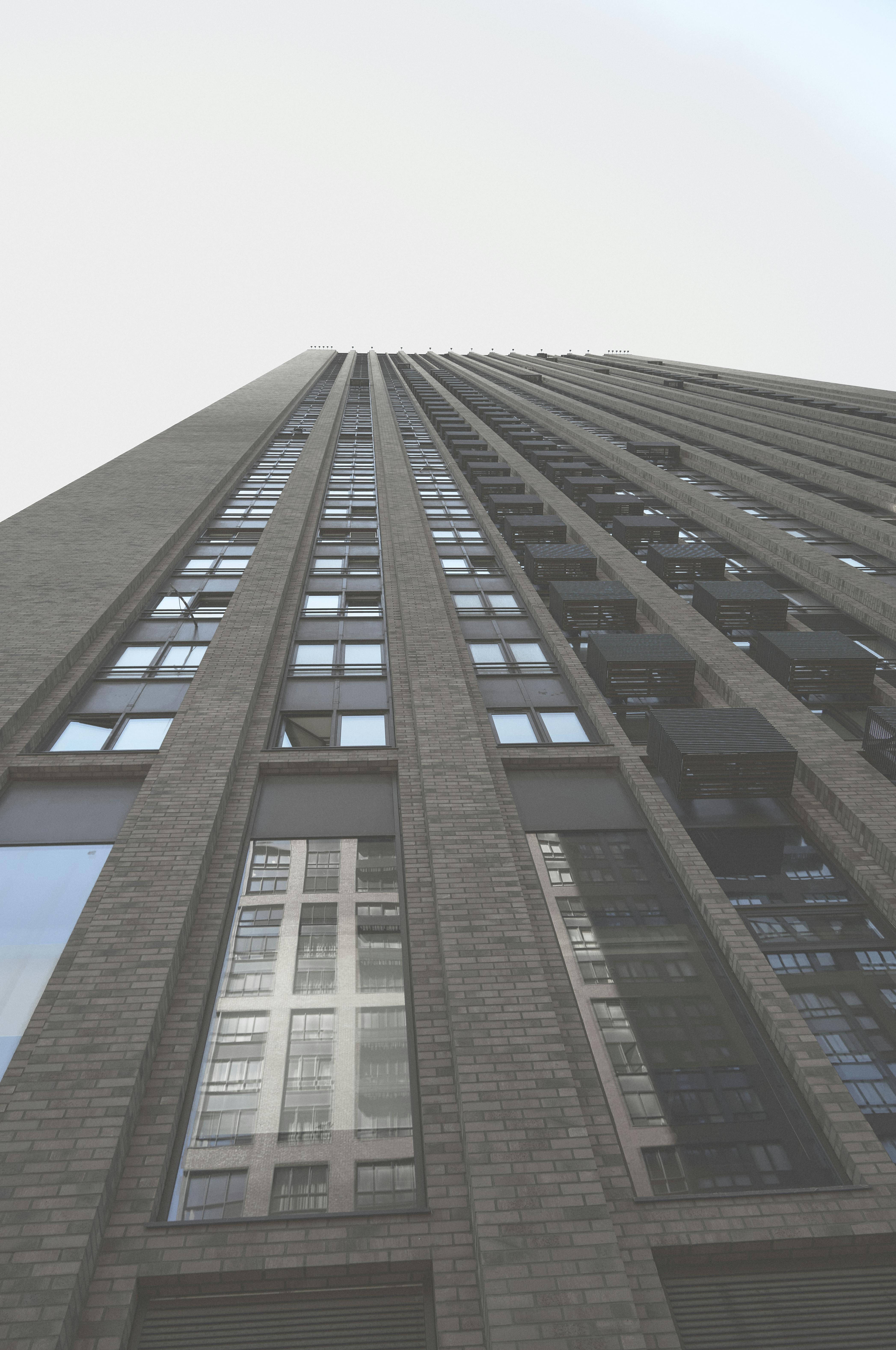Low-Angle Shot of Tall Concrete Building · Free Stock Photo