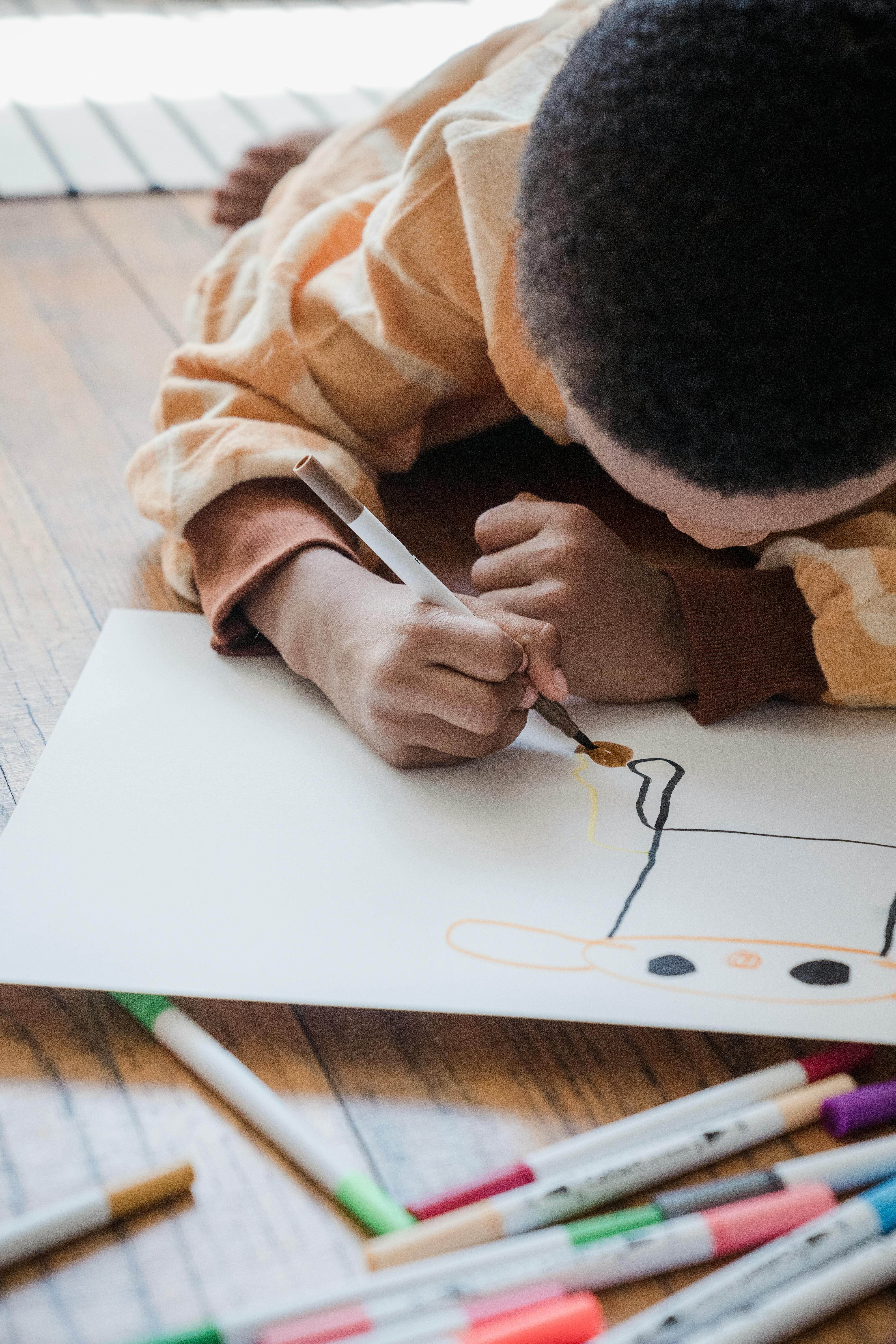 Person Drawing on White Paper · Free Stock Photo