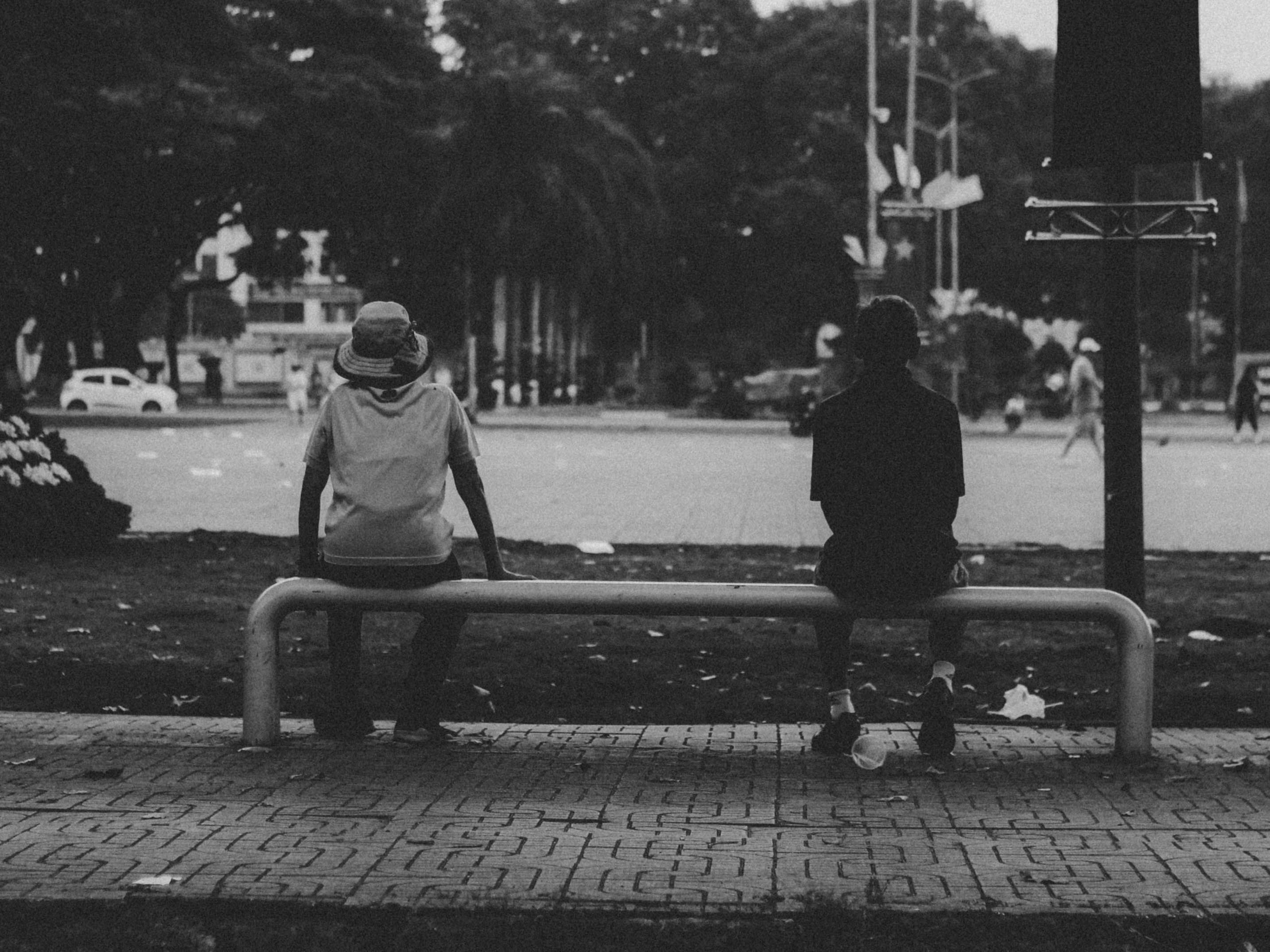 Grayscale Photo of Two People Sitting near the Window · Free Stock Photo
