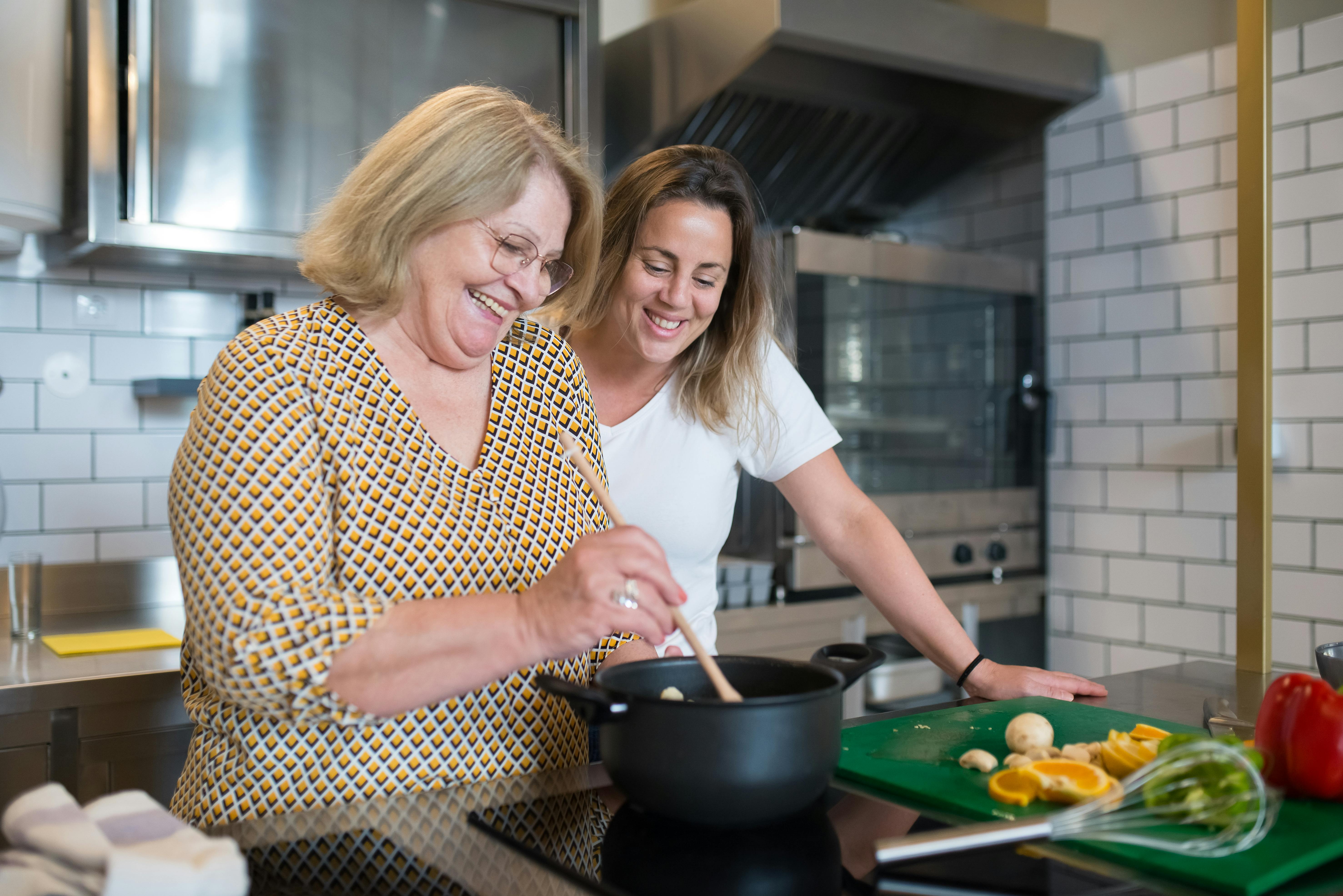 Woman in Standing while Cooking Together · Free Stock Photo