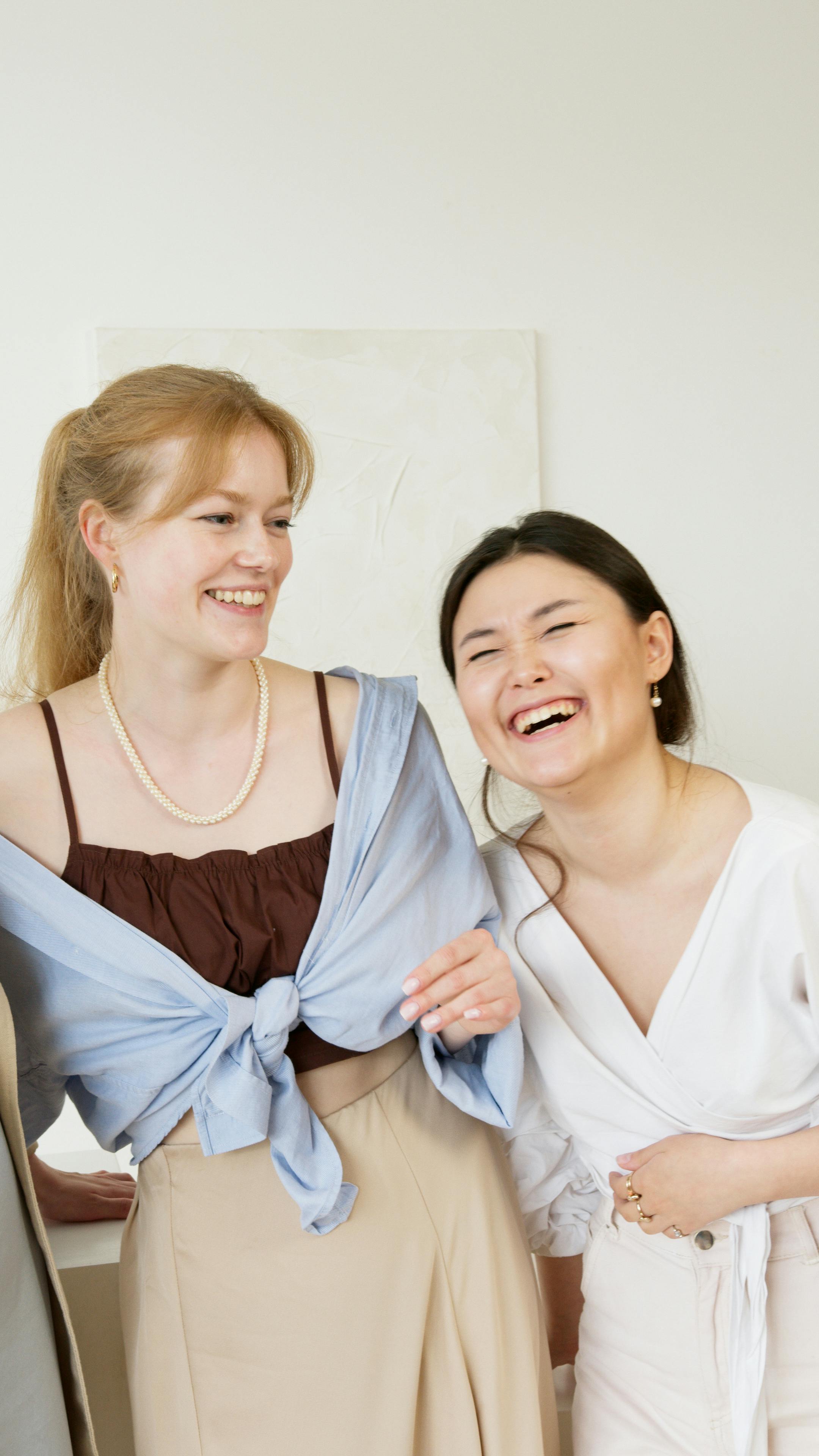 Two Women in Traditional Clothes Laughing Together · Free Stock Photo