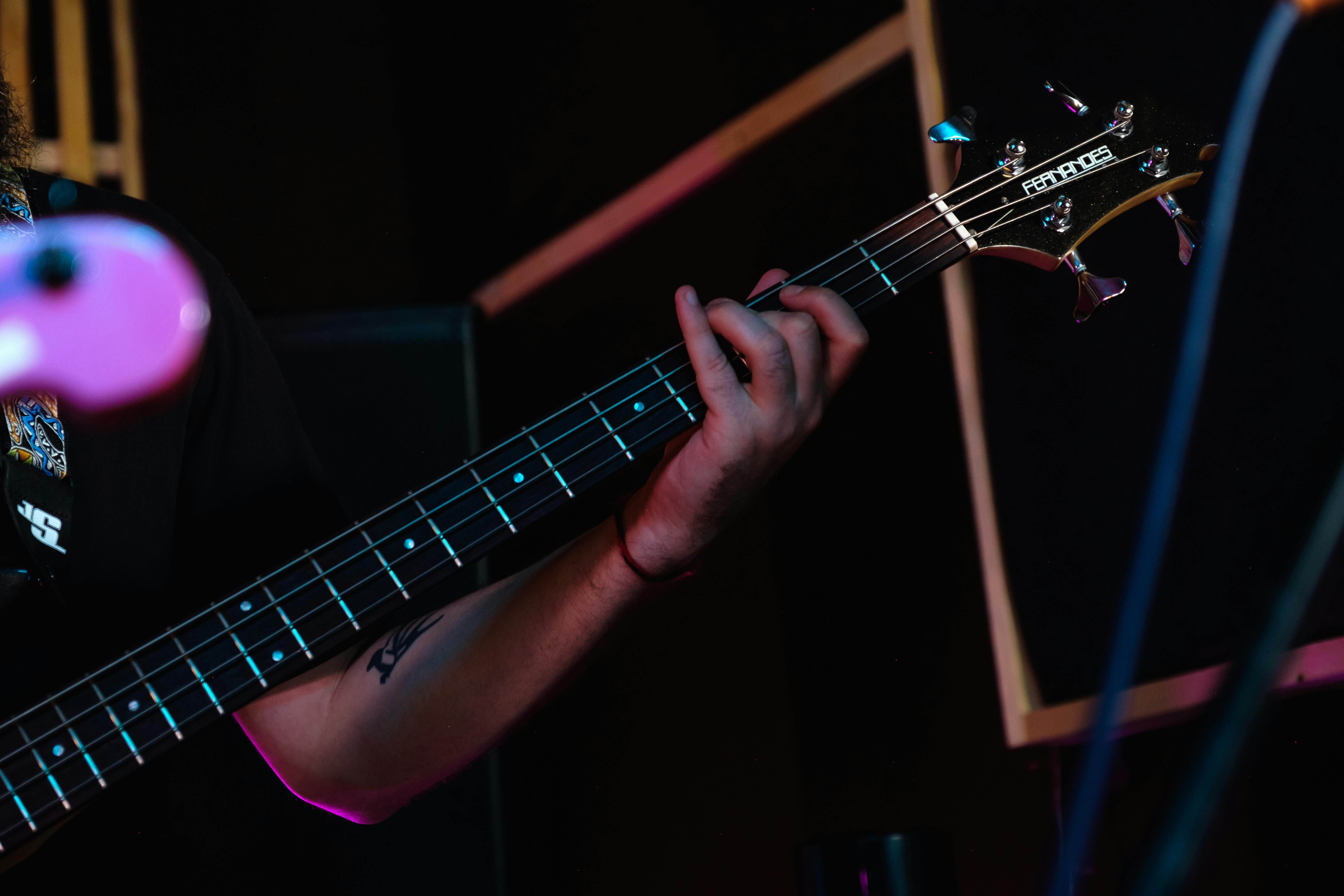 Close-Up Shot of a Person Playing a Bass Guitar · Free Stock Photo