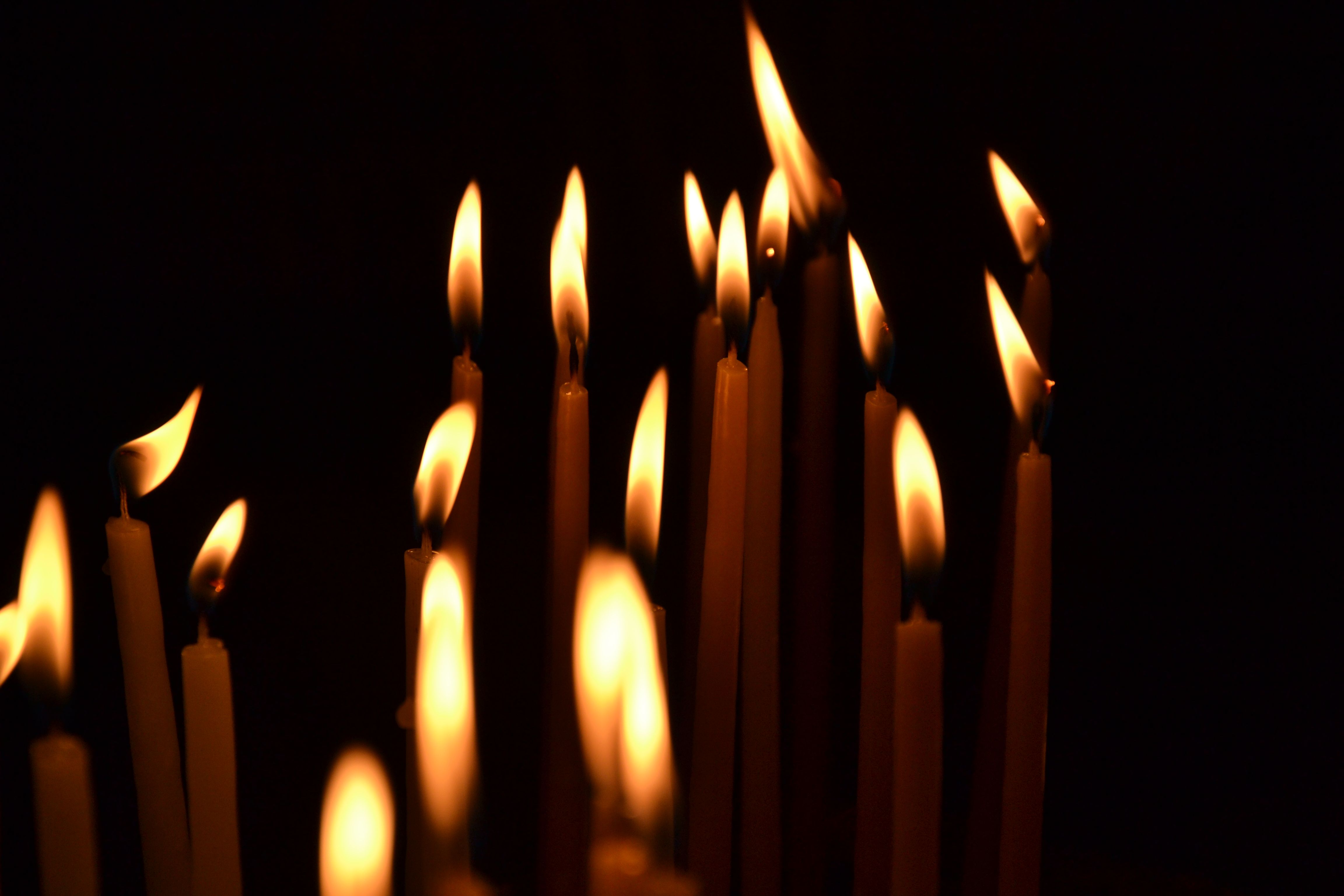 A Person Lighting a Candle · Free Stock Photo