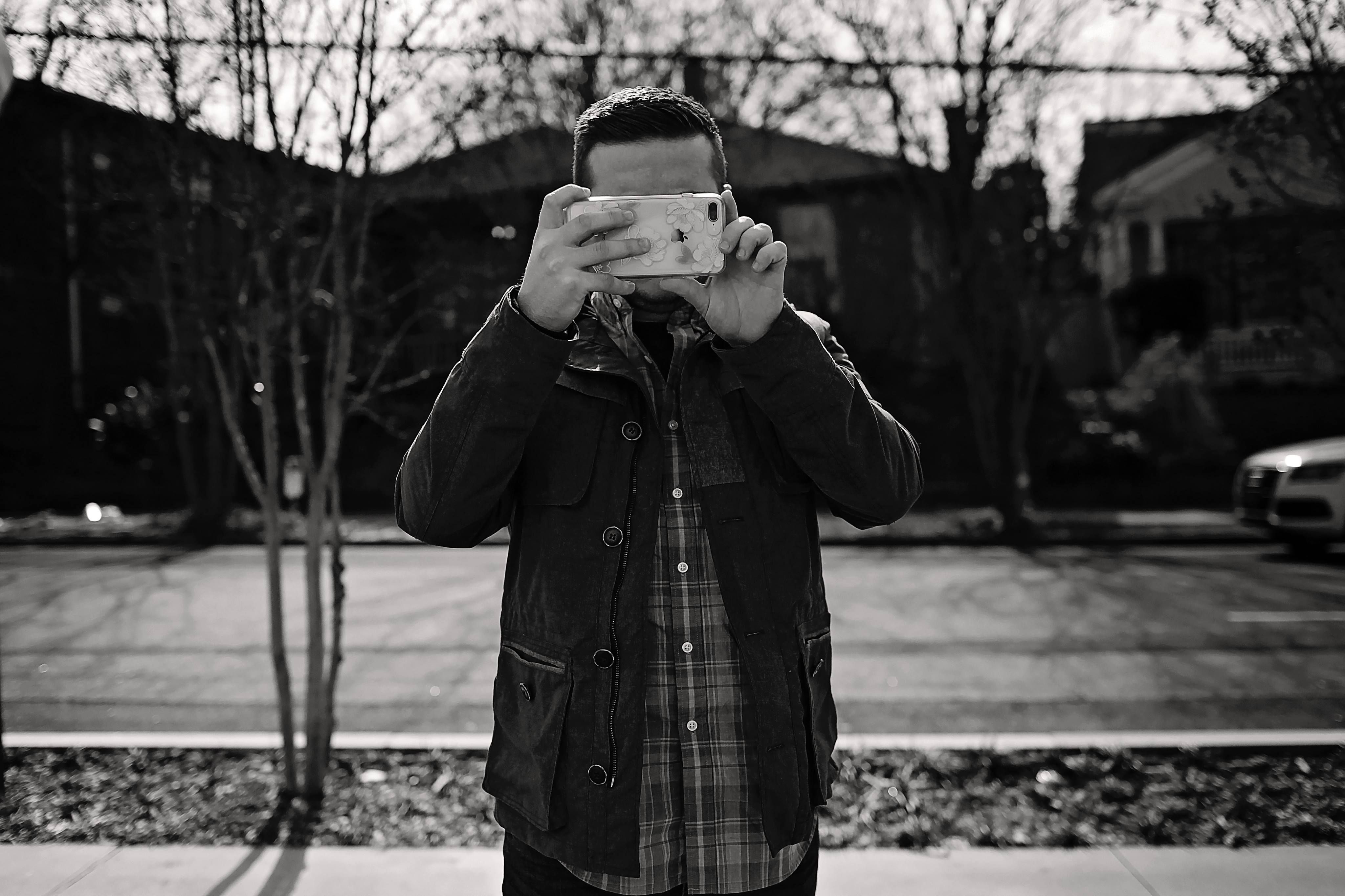 Man taking photo on mobile phone on street · Free Stock Photo