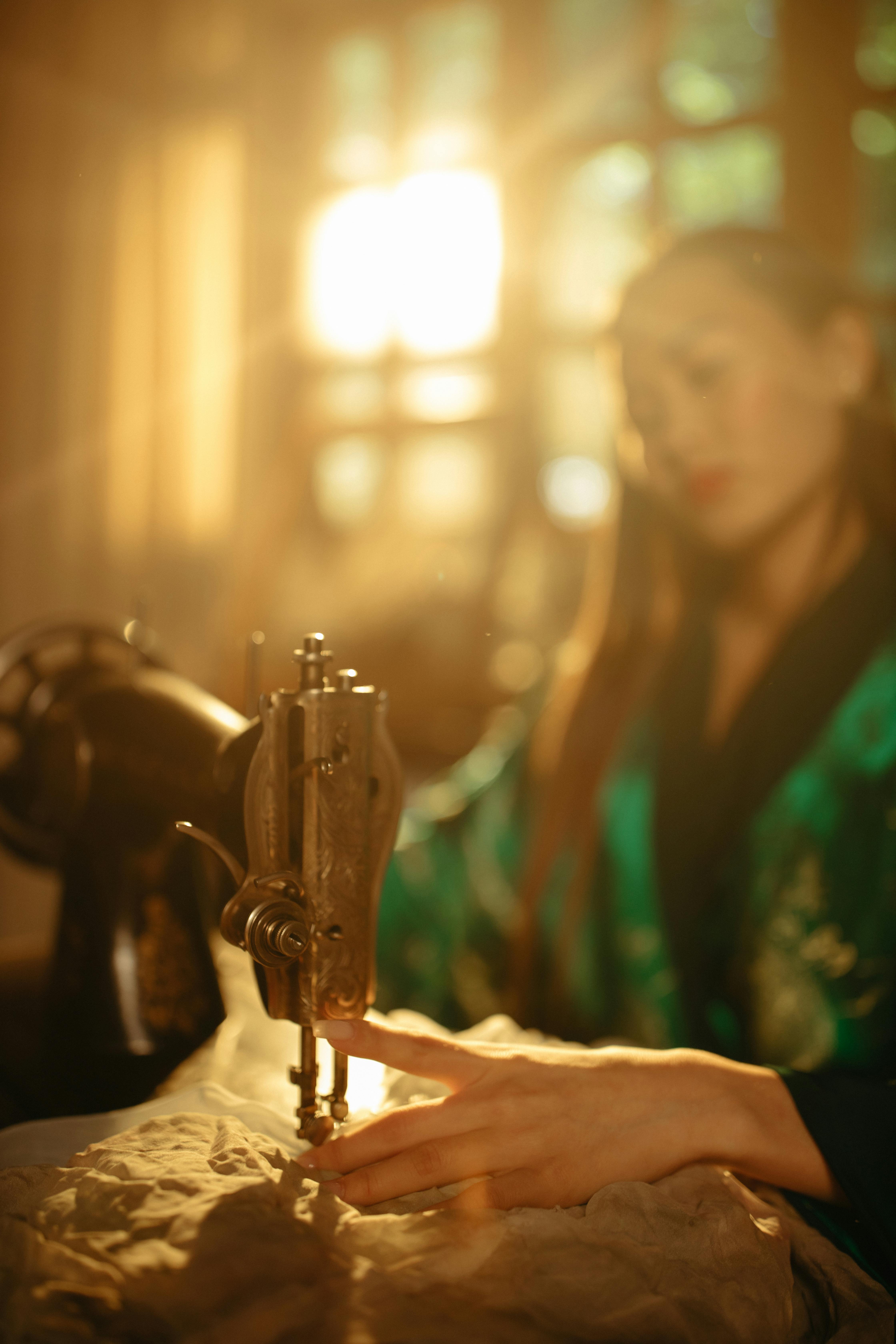 Woman Sewing Clothes in Sunlight · Free Stock Photo