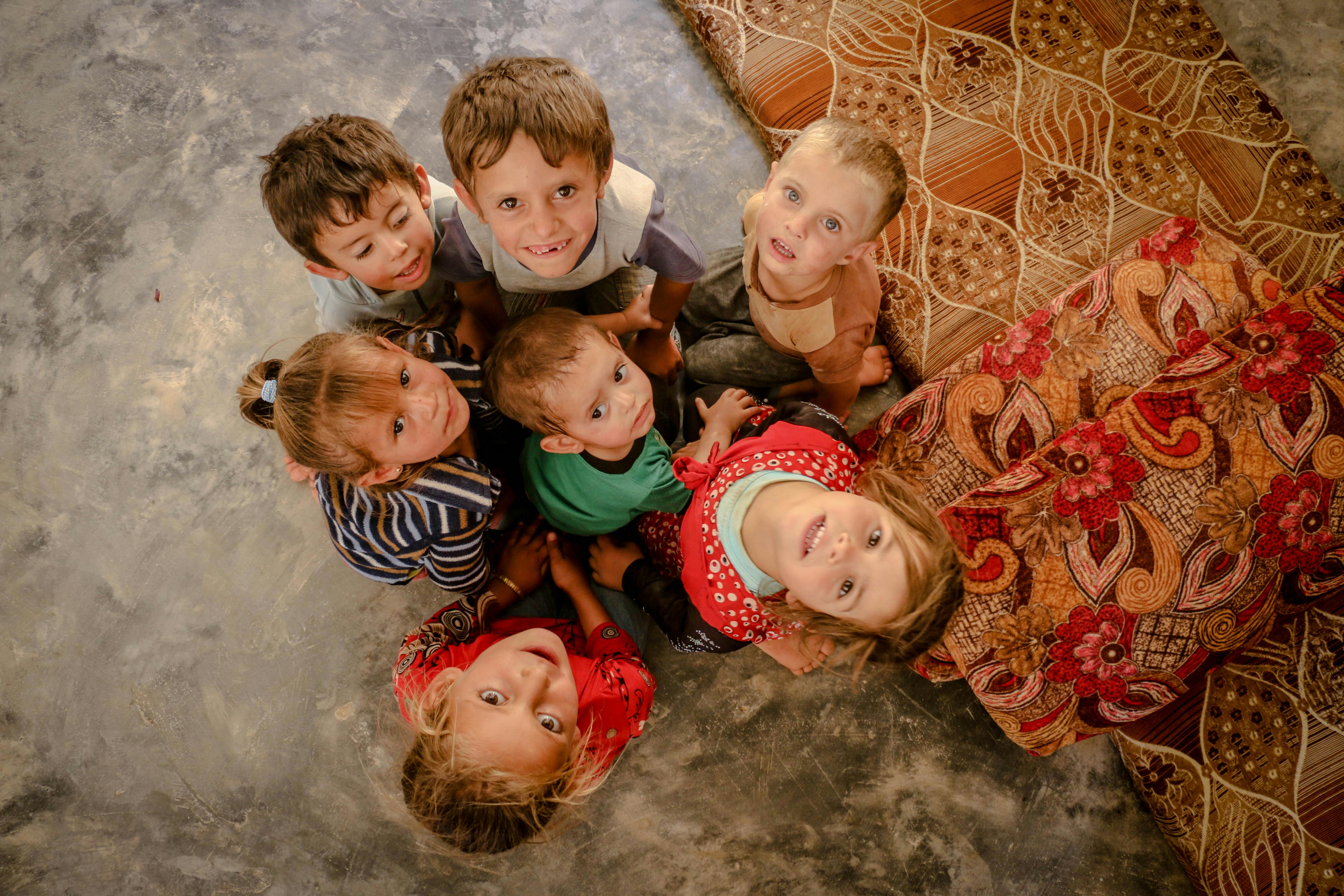Kids Smiling while Looking Up · Free Stock Photo