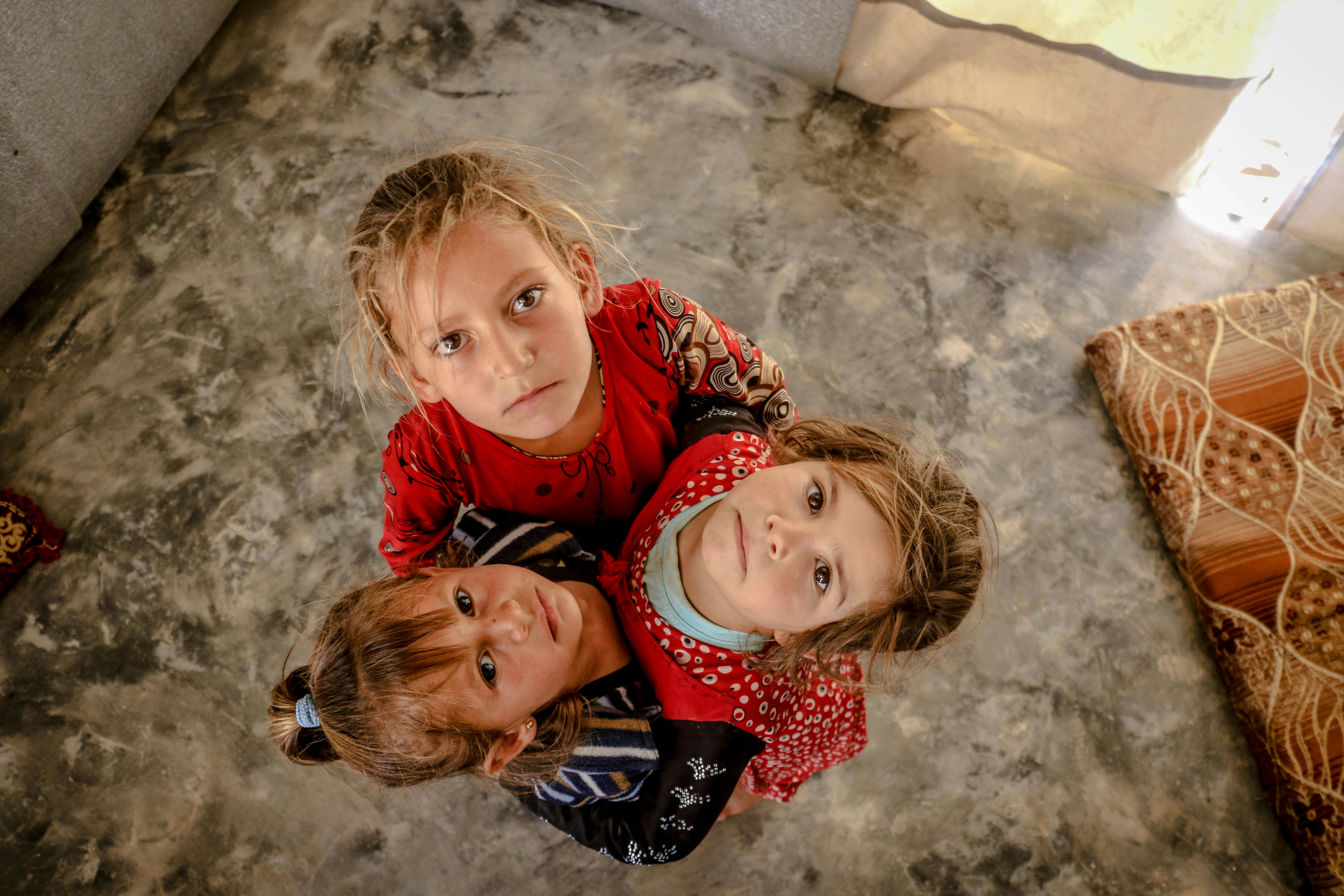 A Photo of Three Kids Looking Up · Free Stock Photo