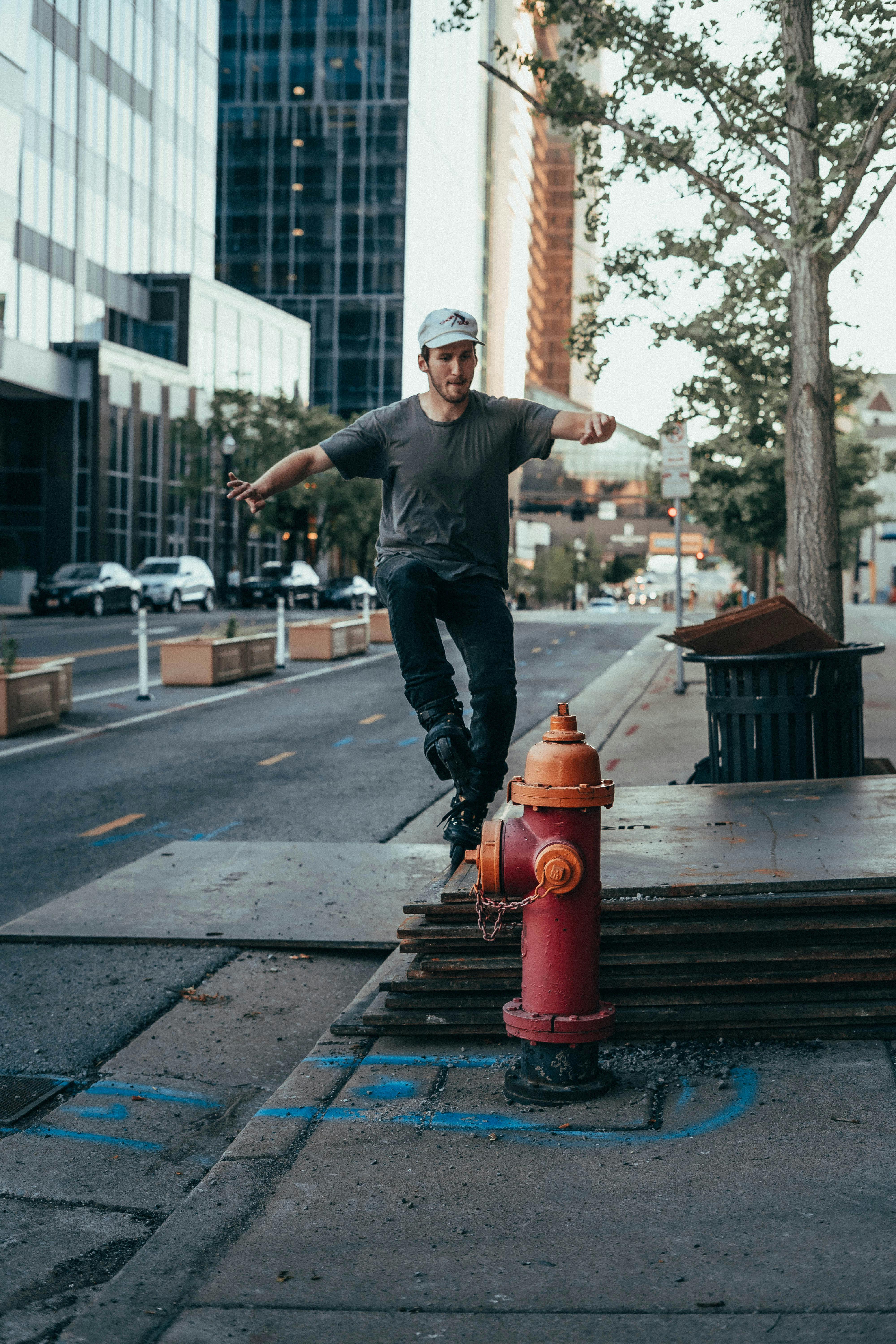 Man in White Long-sleeved Shirt Holding Red Fire Hydrant · Free Stock Photo