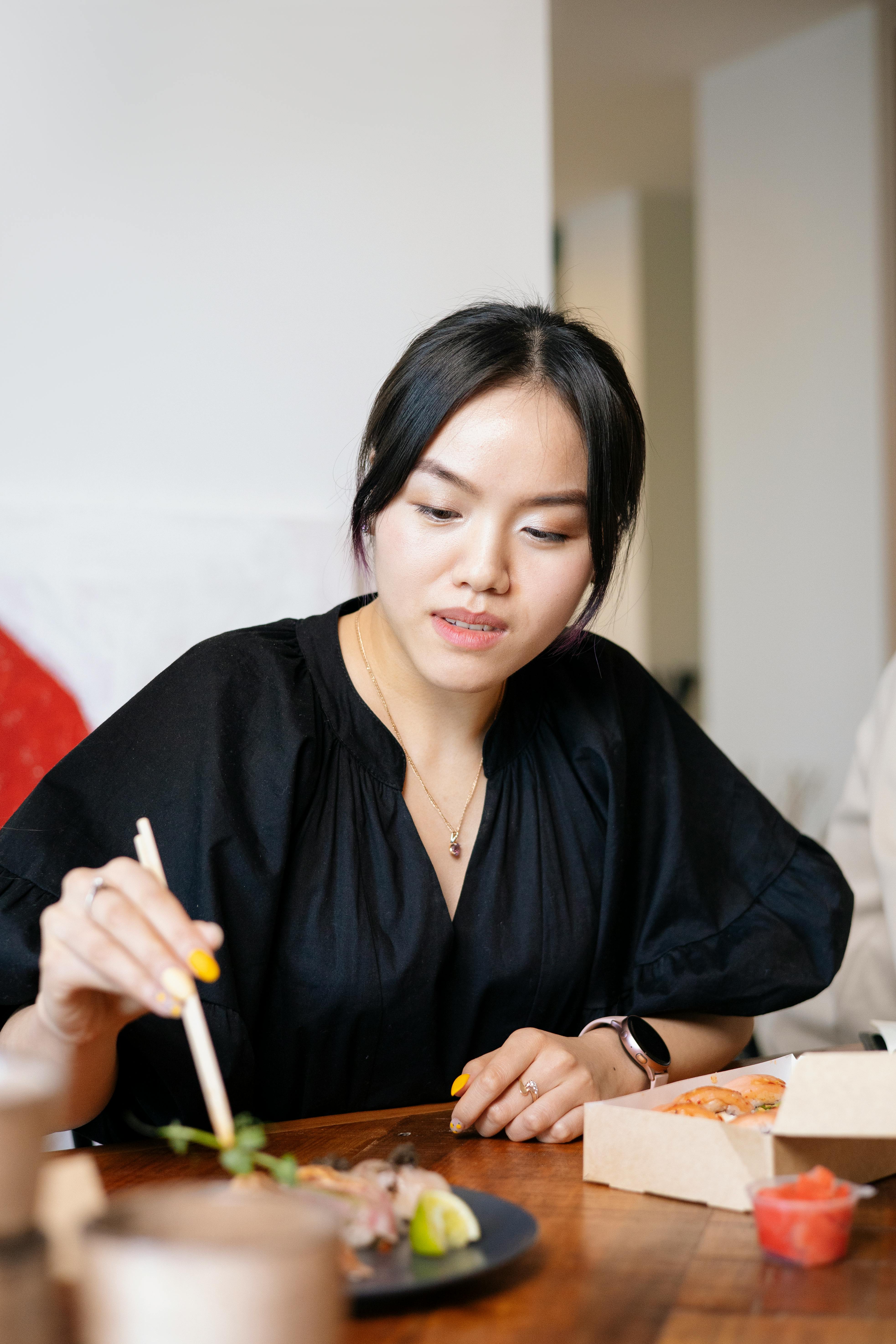 Woman Holding Chopsticks with Food · Free Stock Photo