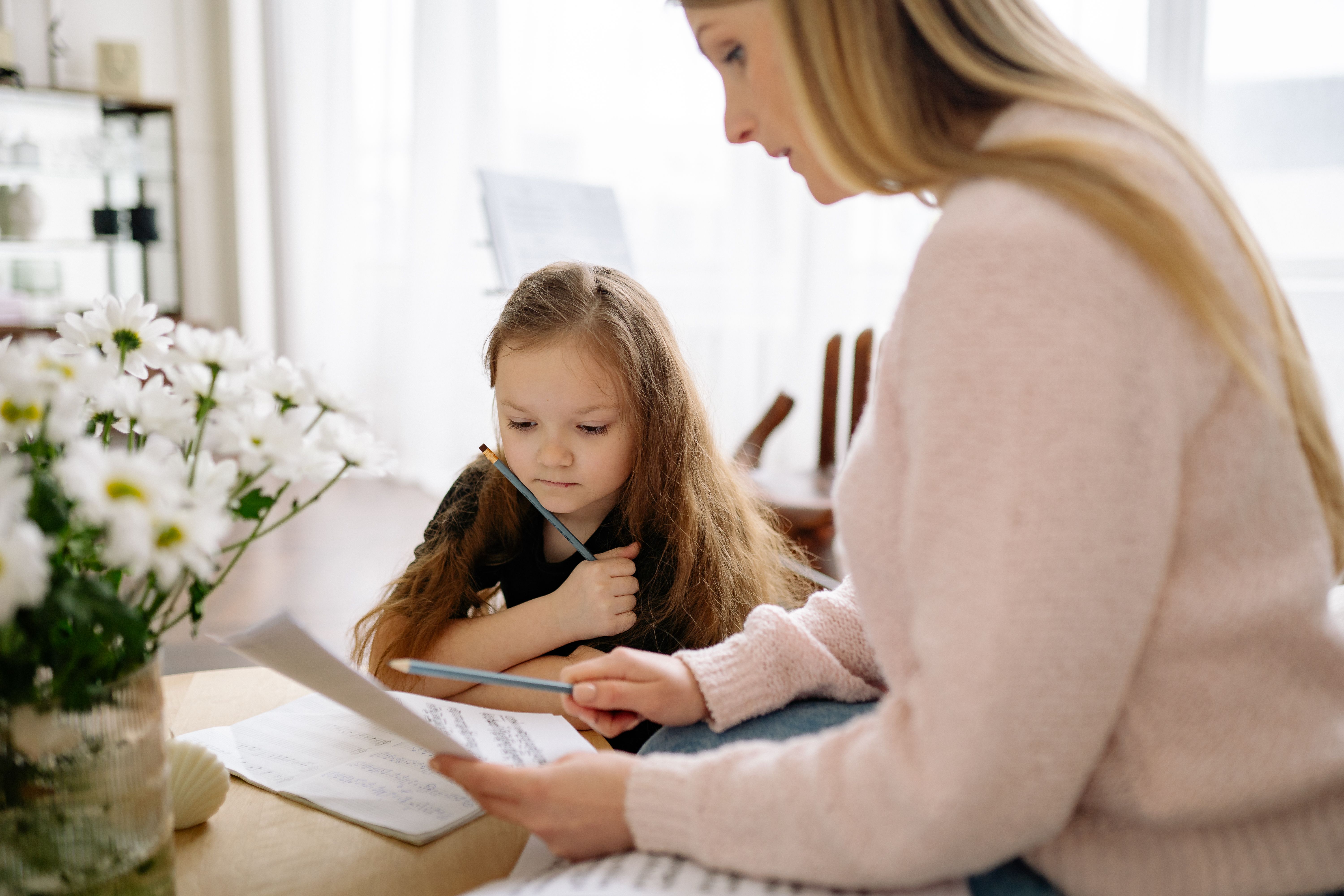 Woman in Pink Sweater Teaching a Girl · Free Stock Photo