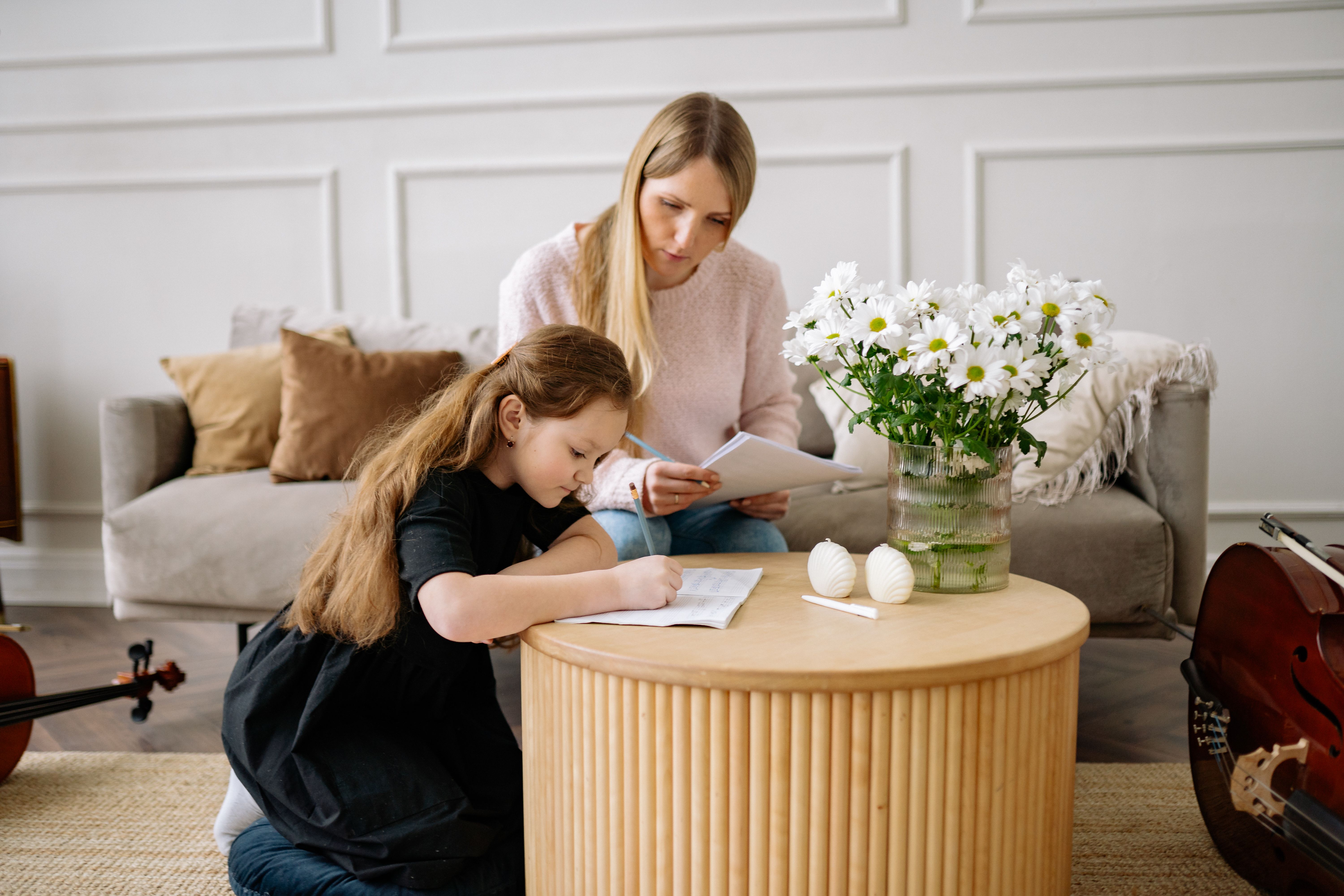 Woman Teaching Girls Sitting by the Table · Free Stock Photo