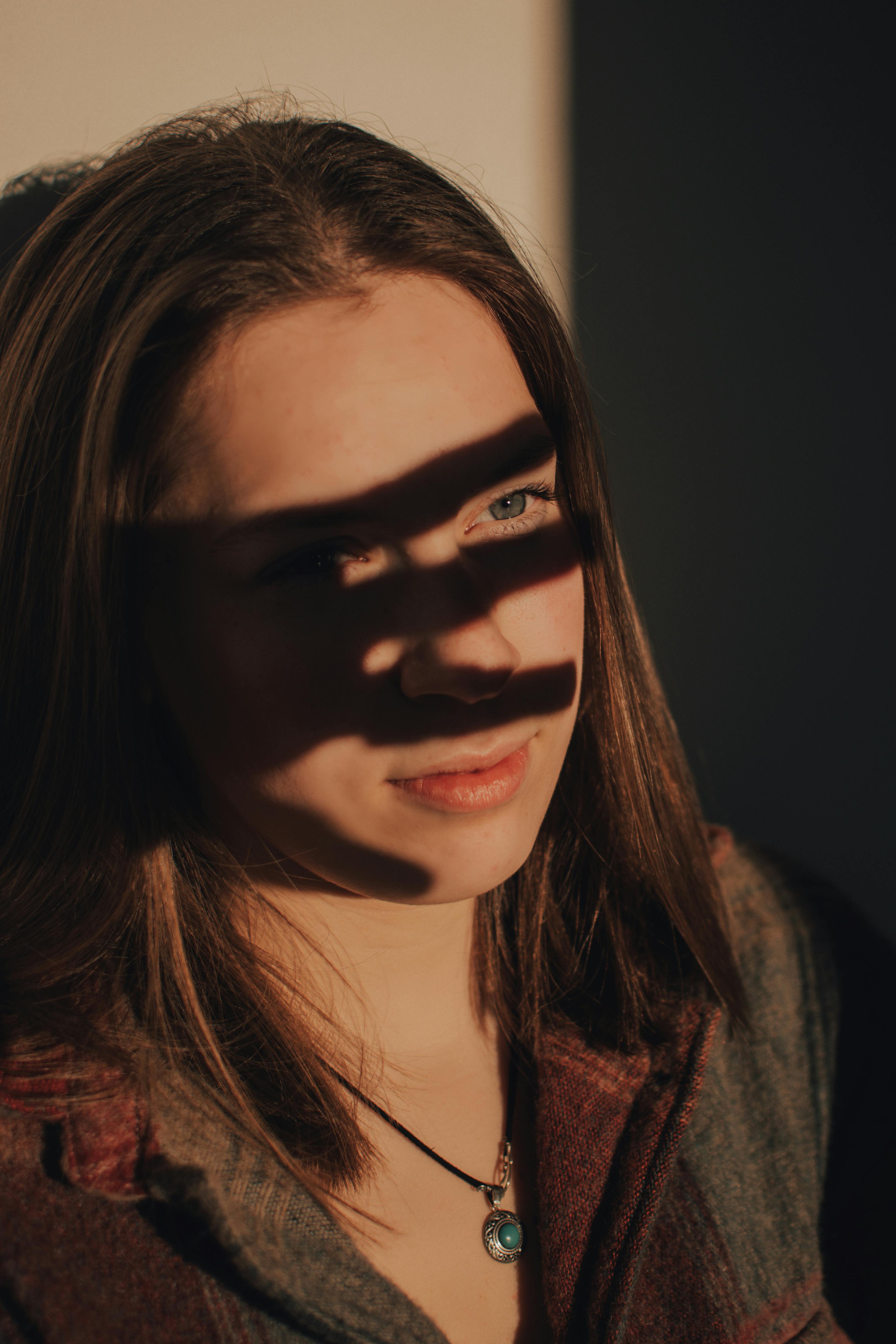 Close-up Portrait of Young Woman with Shadow on Face · Free Stock Photo