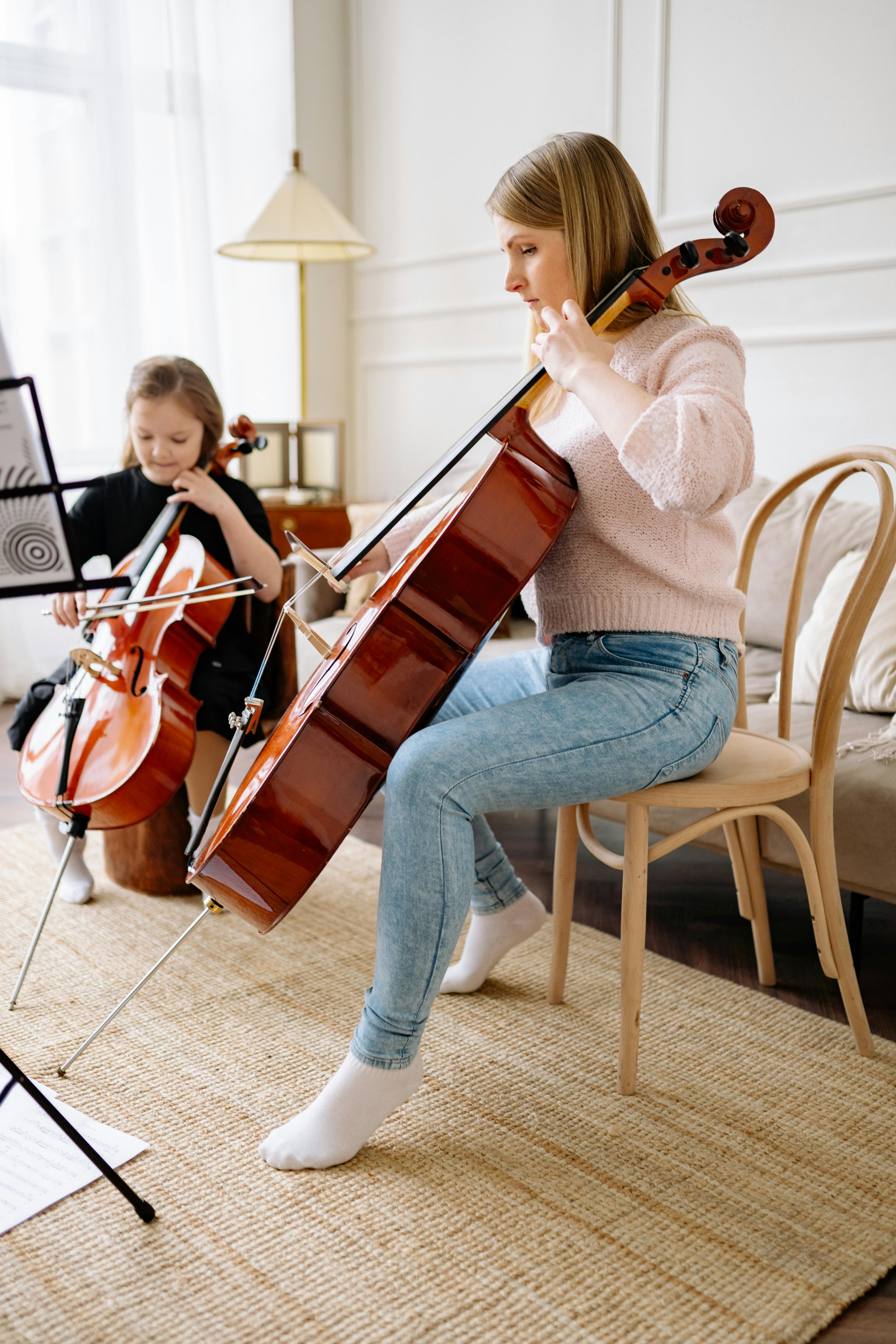 Woman and a Girl Playing Cello Together · Free Stock Photo