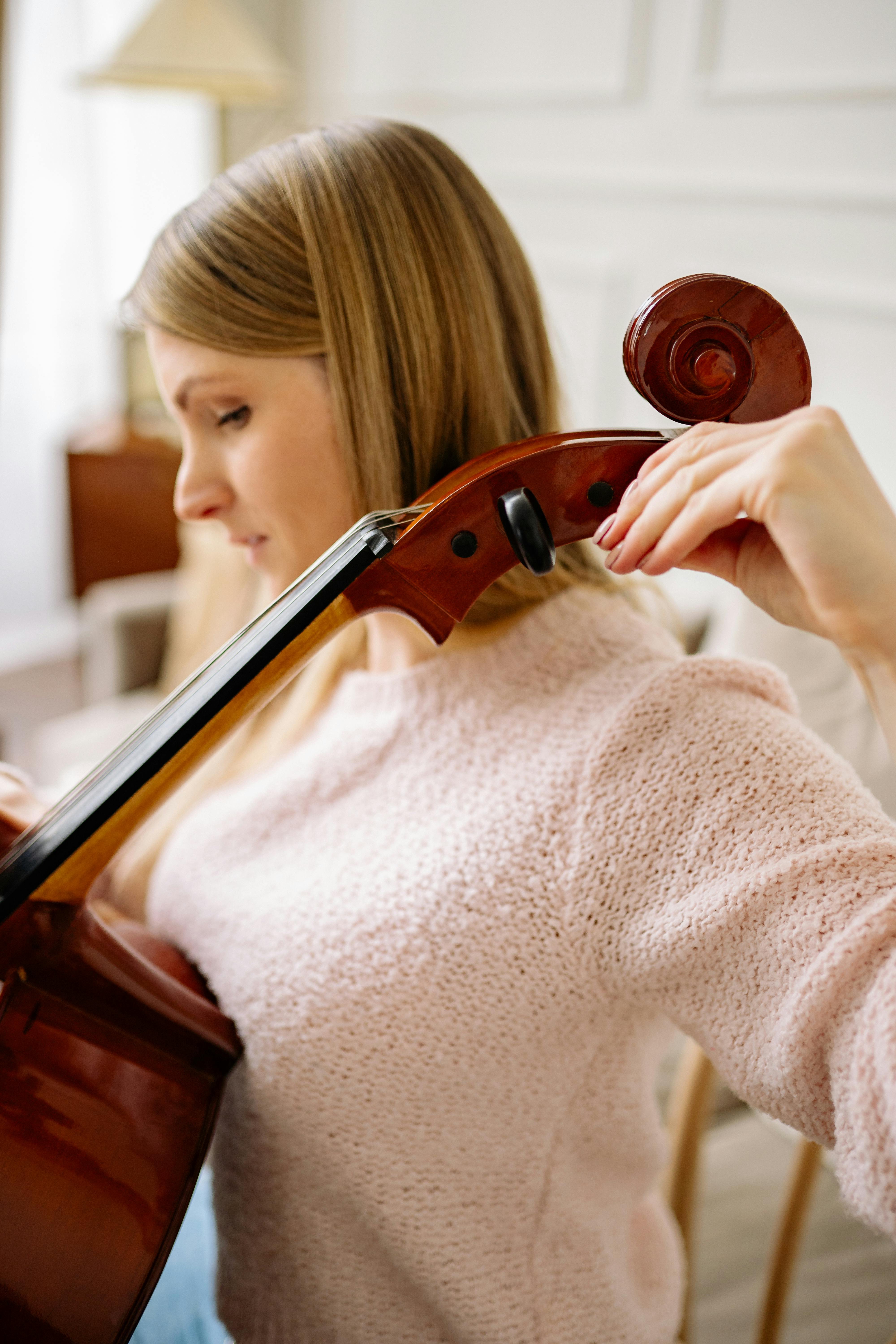 A Woman in Yellow Shirt Playing a Bowed String Instrument · Free Stock ...