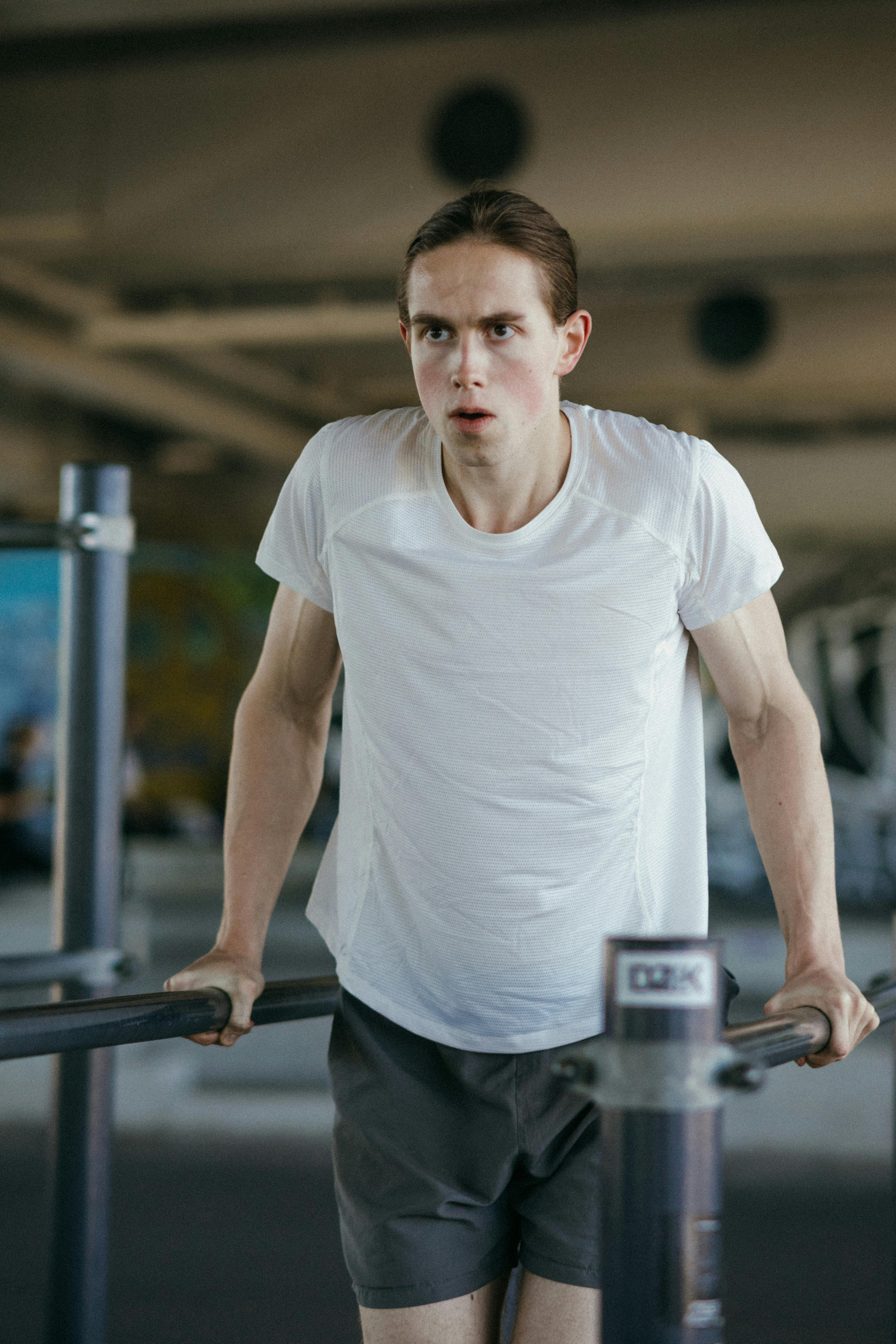 A Man in White Shirt Exercising · Free Stock Photo