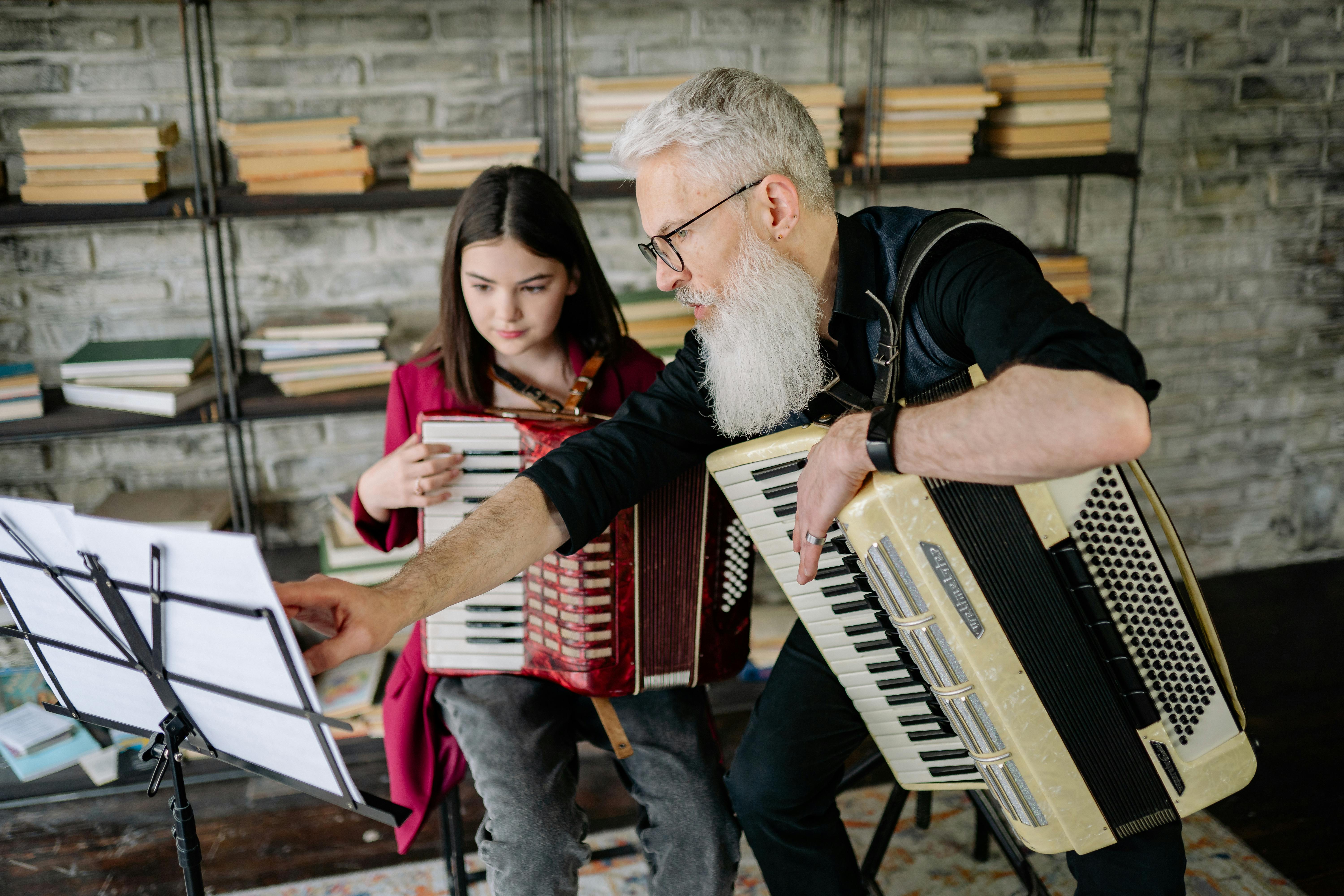 A Man and a Girl Playing Accordions · Free Stock Photo