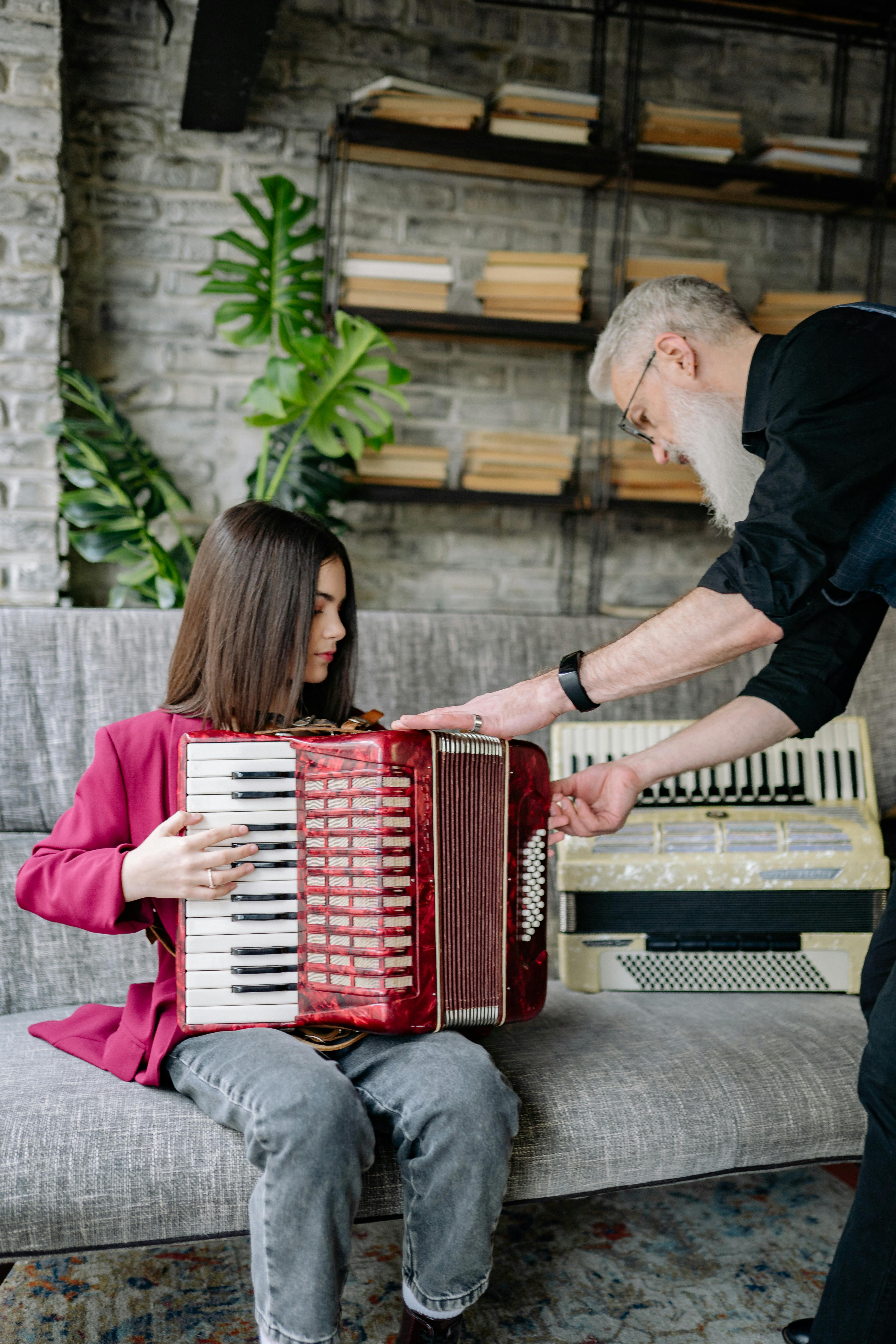 A Man and a Girl Playing Accordions · Free Stock Photo