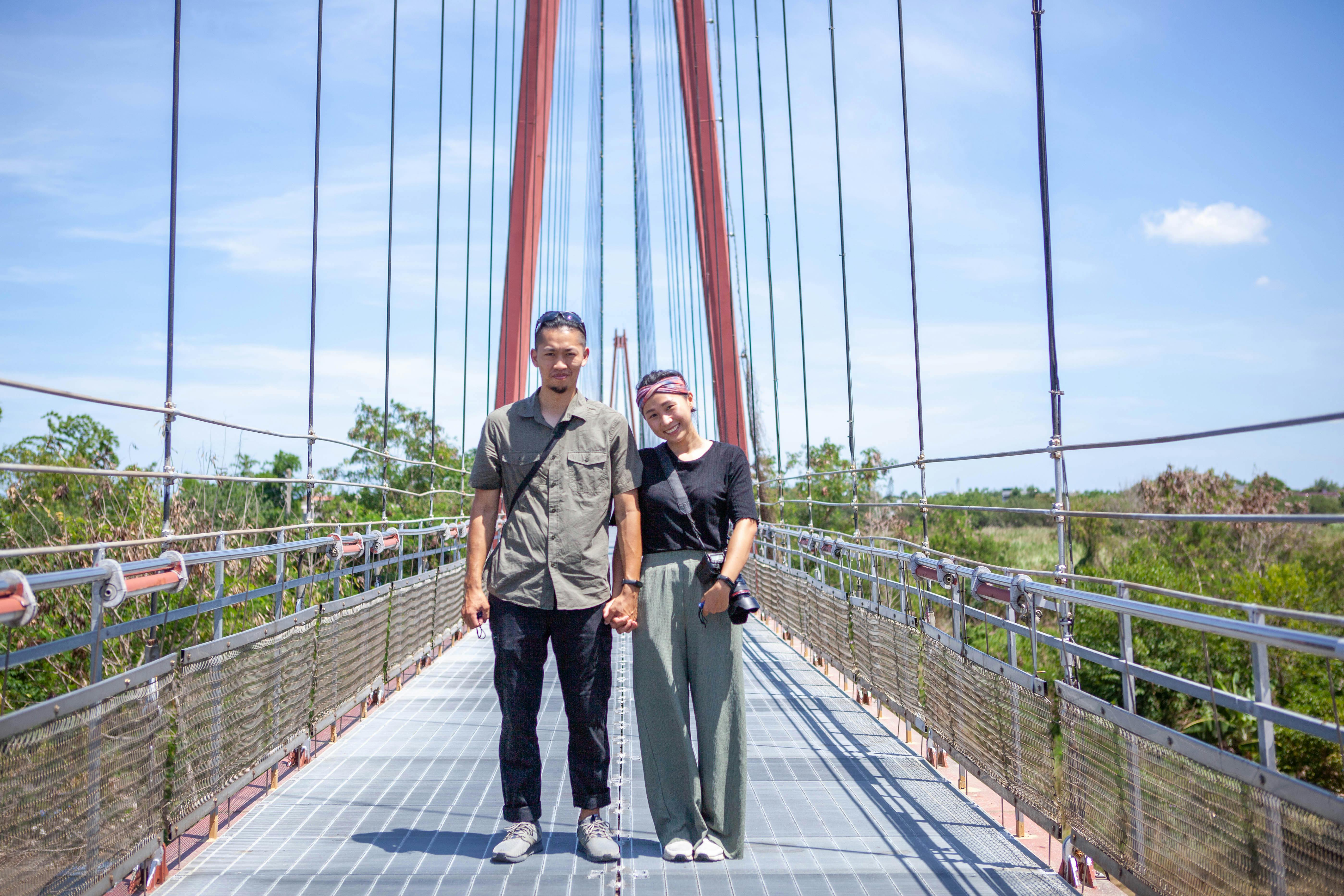 A Couple Standing on a Bridge · Free Stock Photo