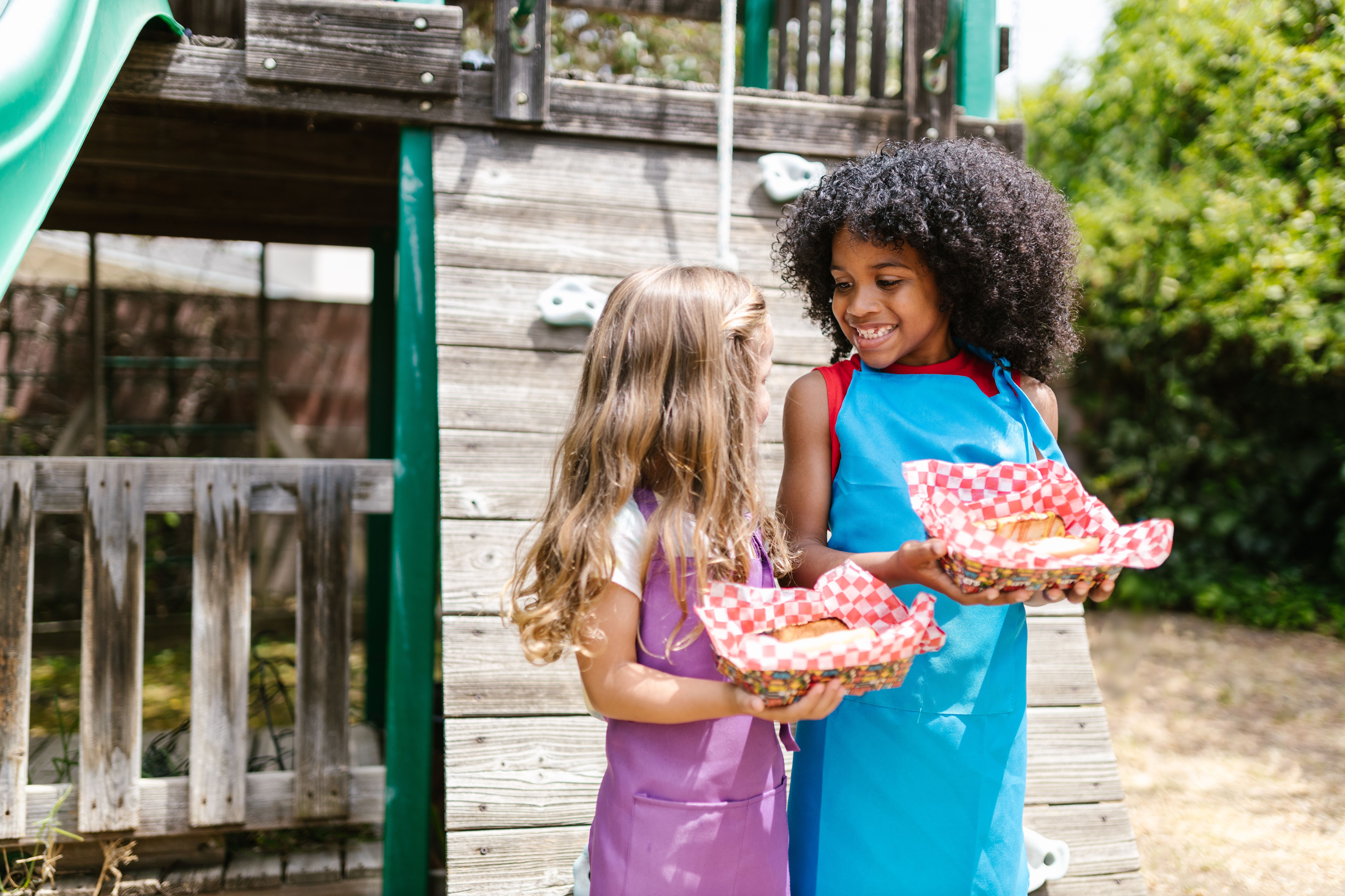 Two Girls Holding Sandwiches in a Box · Free Stock Photo