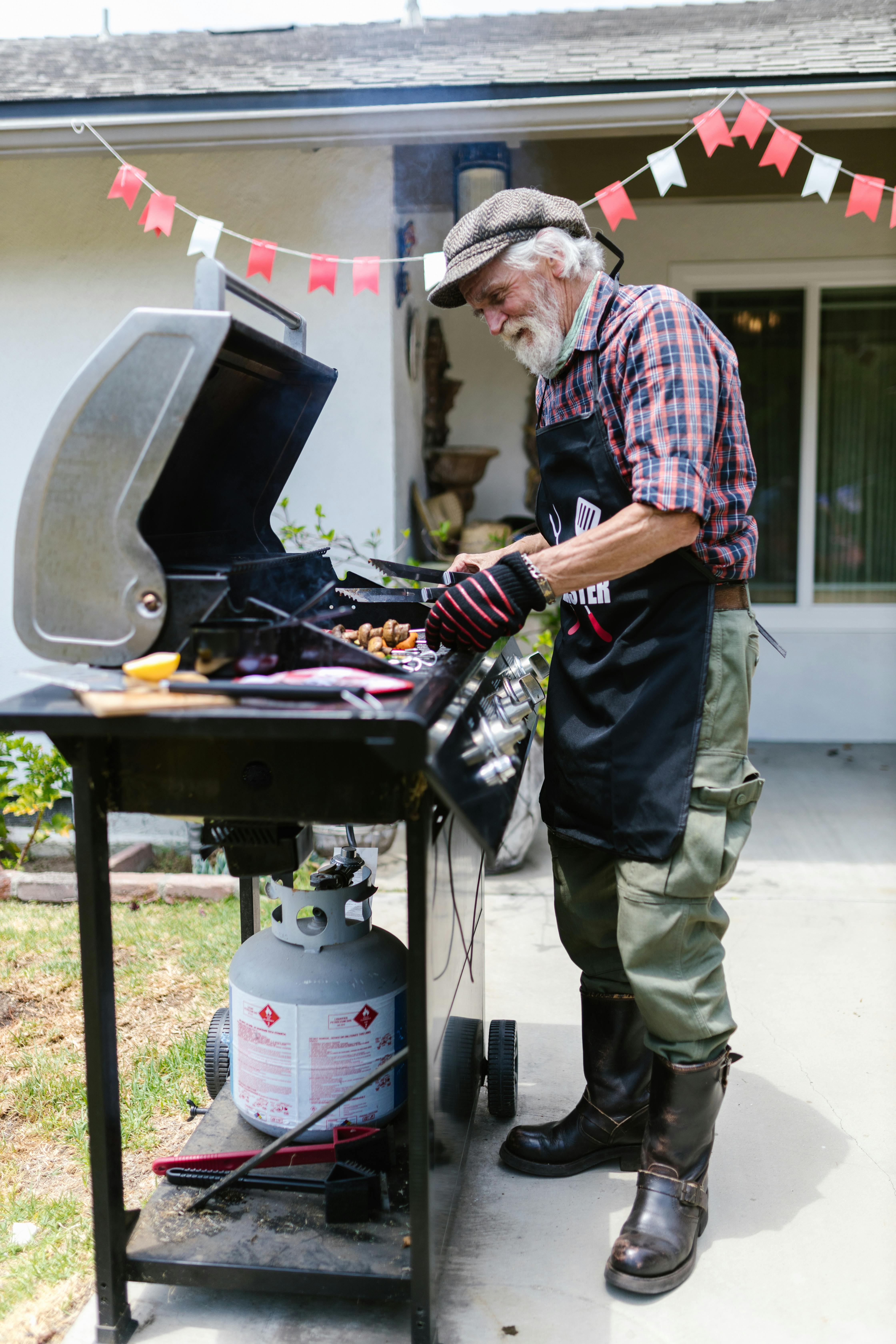 Elderly Man using Griller · Free Stock Photo