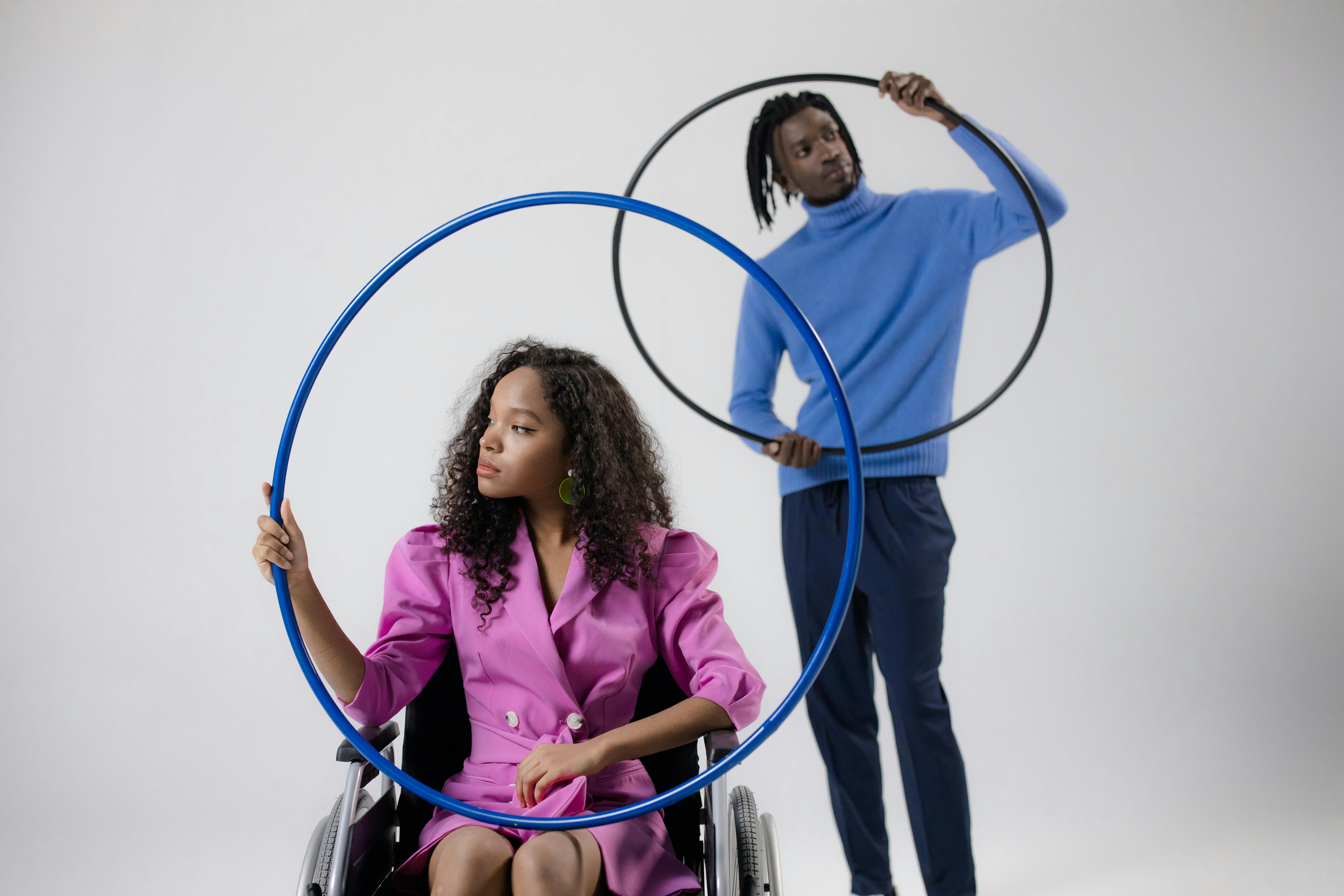 A Man and Woman Holding Hula Hoops · Free Stock Photo