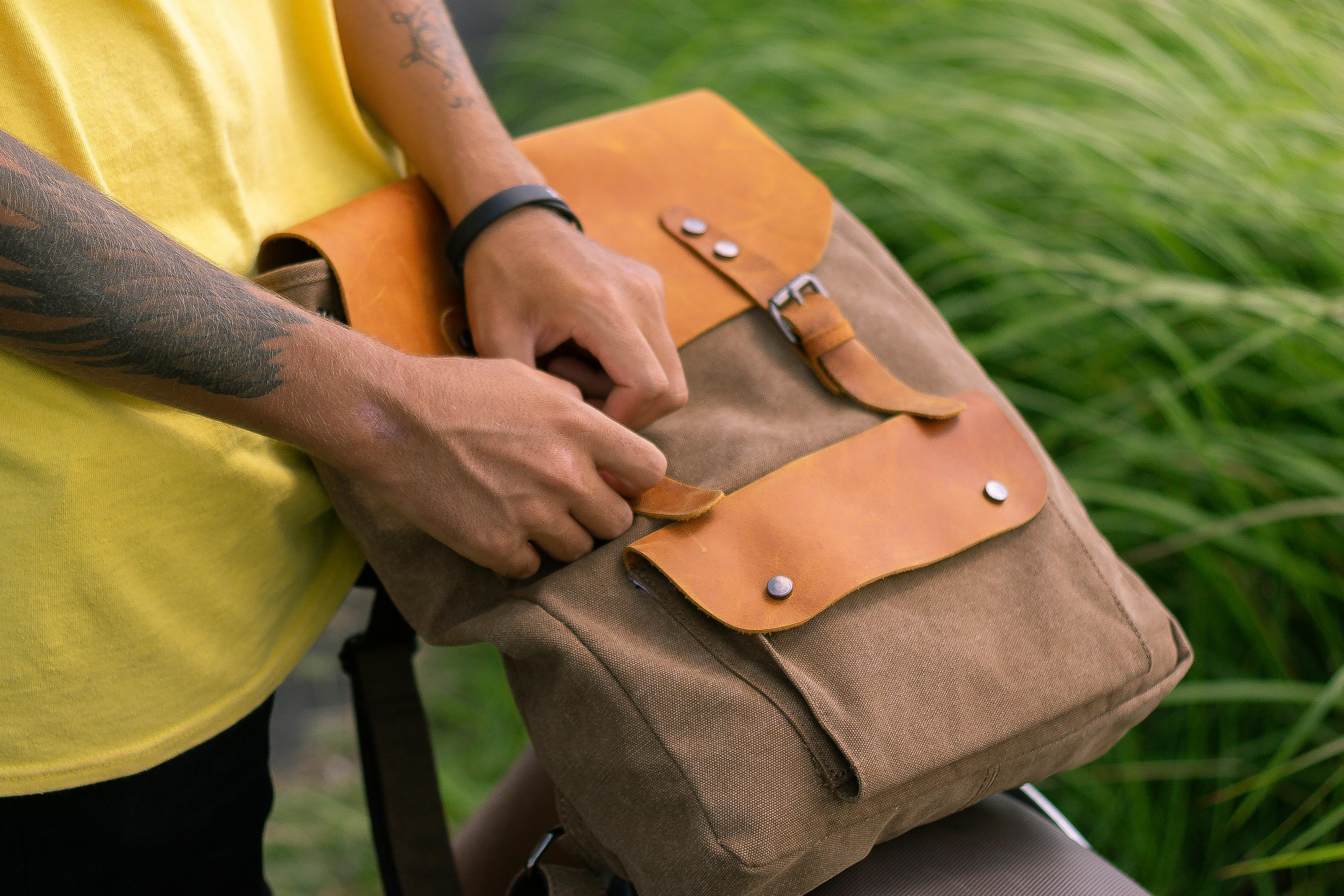 Person Holding a Brown Backpack · Free Stock Photo
