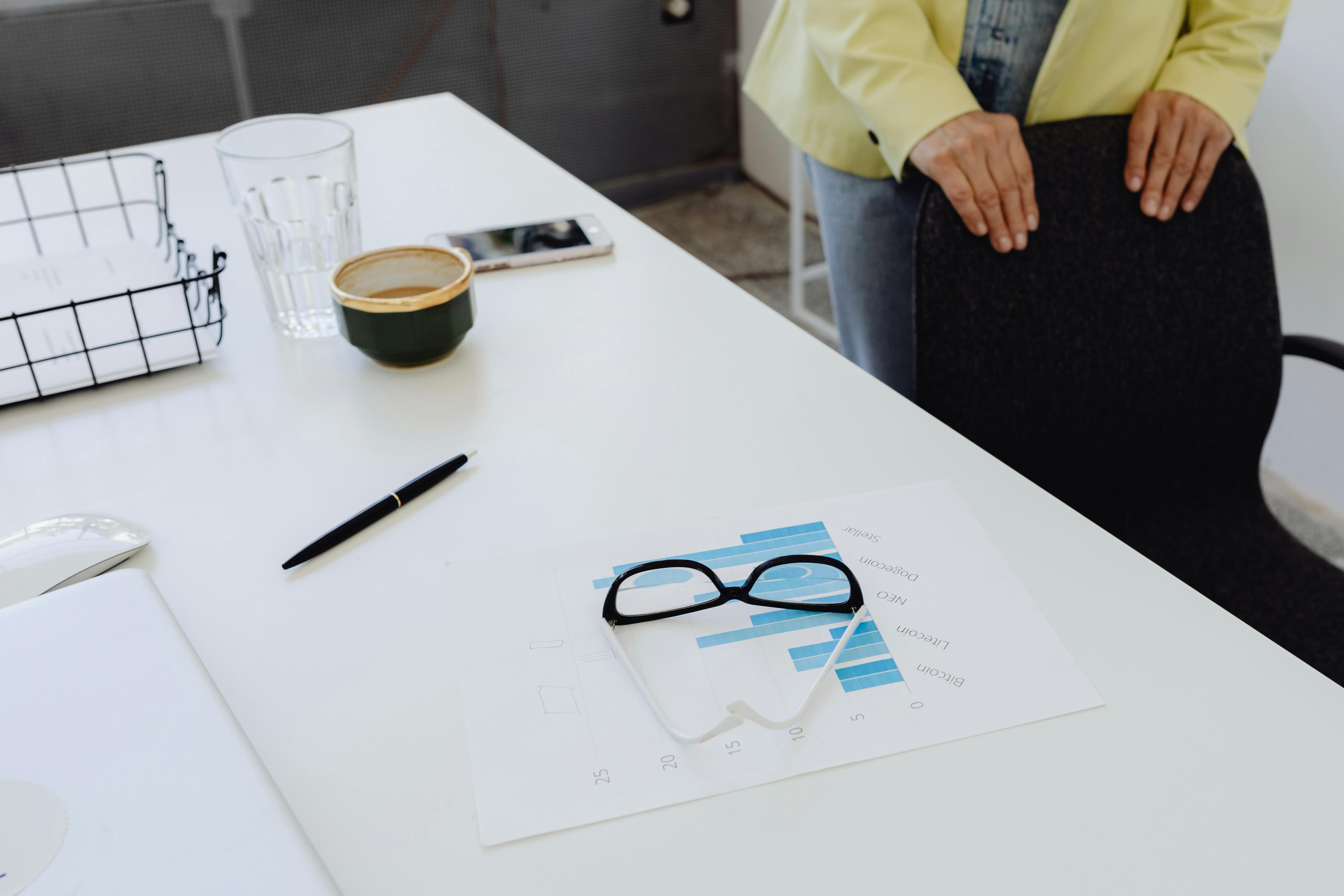Woman Standing beside the Desk in an Office · Free Stock Photo