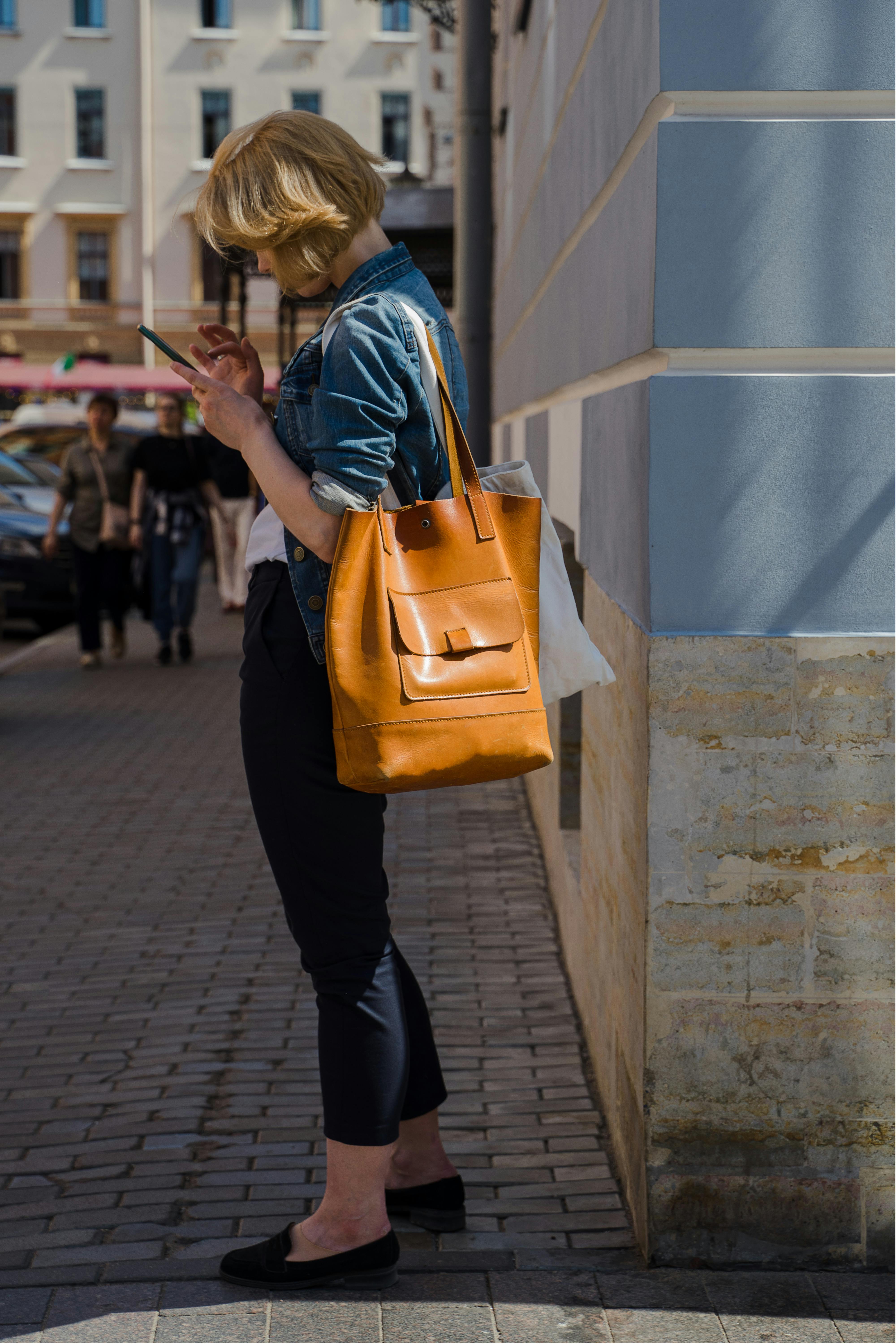Woman Holding Silverware While Looking at Phone · Free Stock Photo