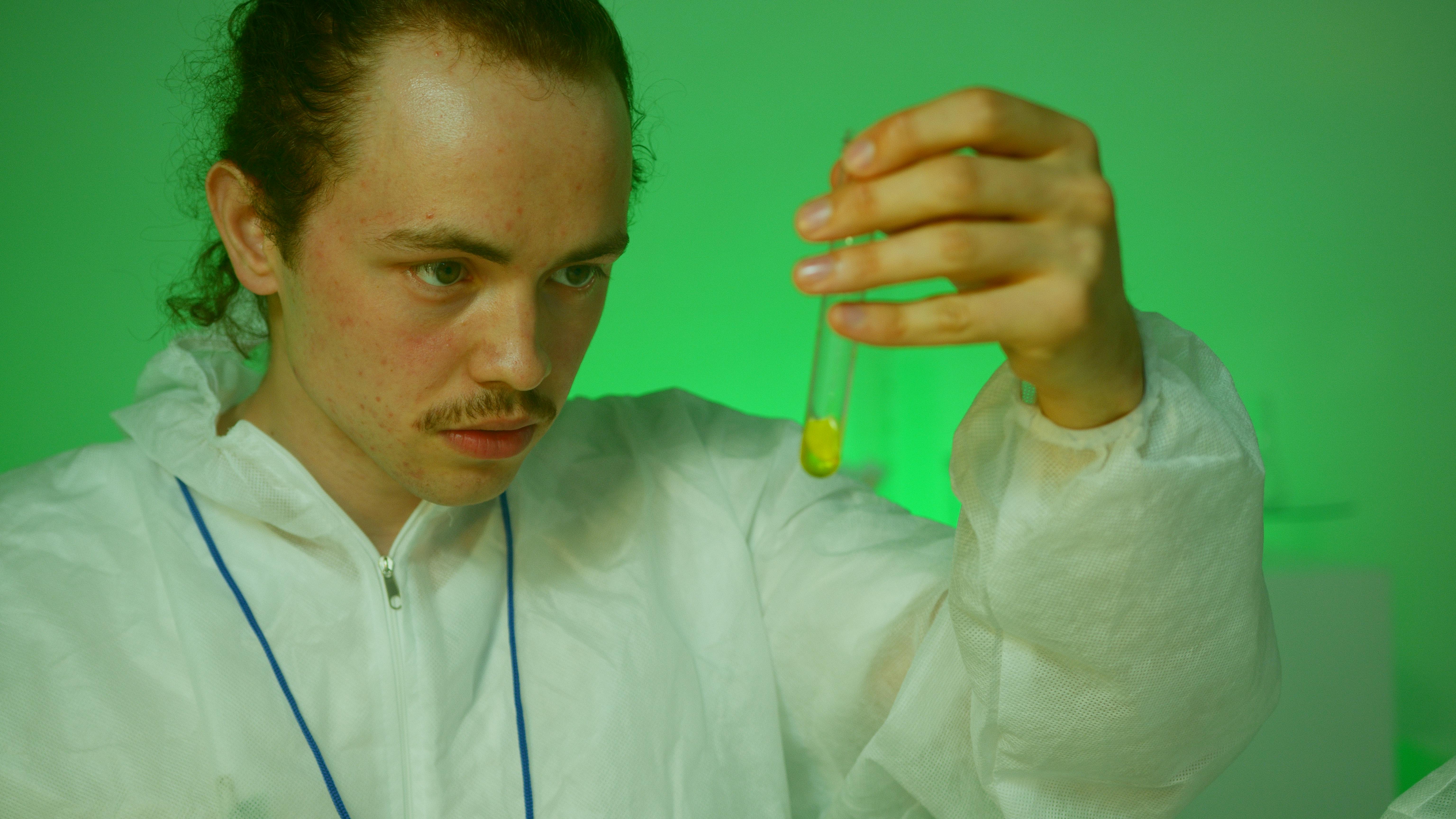 Close-Up Photo of a Man Doing an Experiment · Free Stock Photo