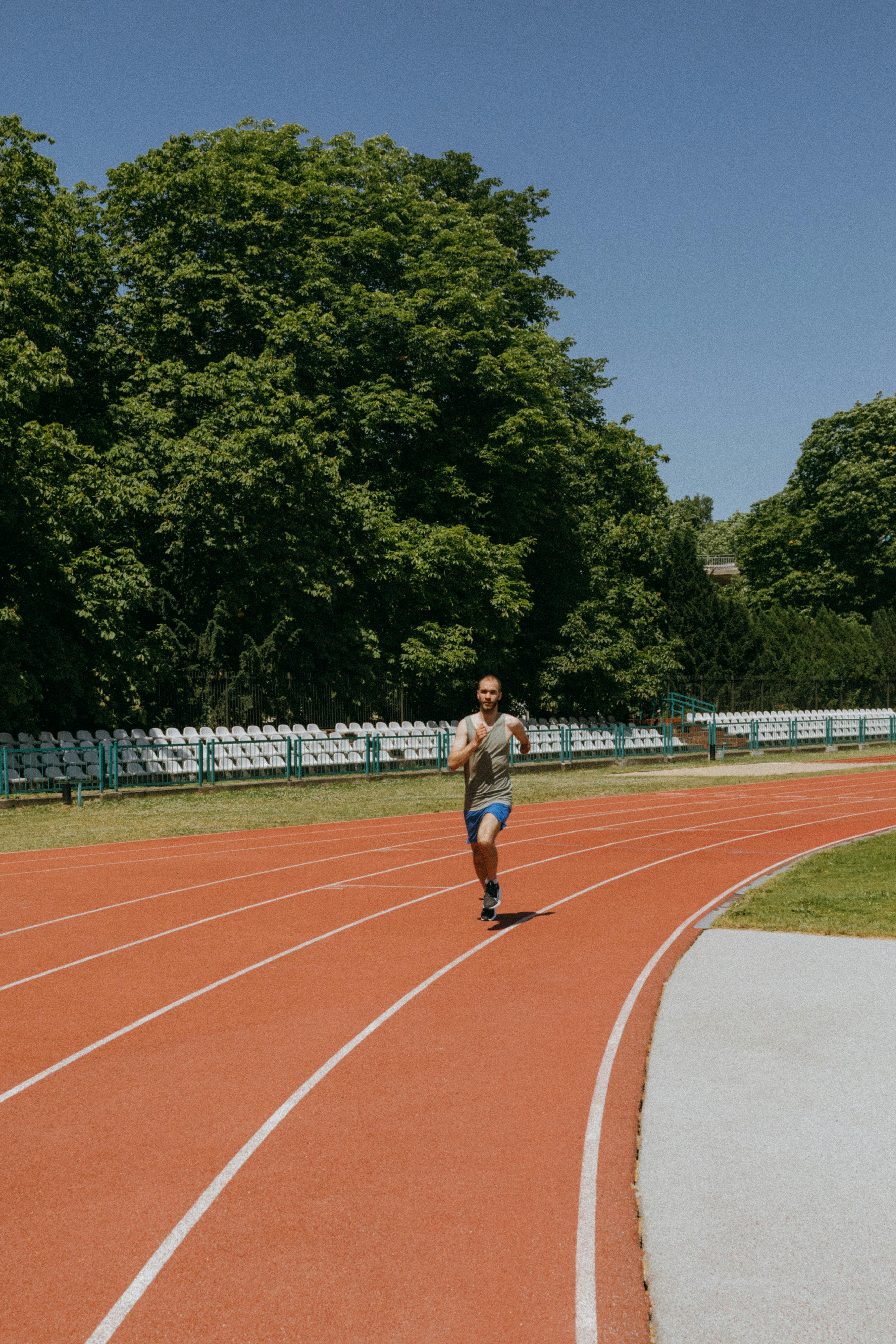 Man Running on a Track Field · Free Stock Photo