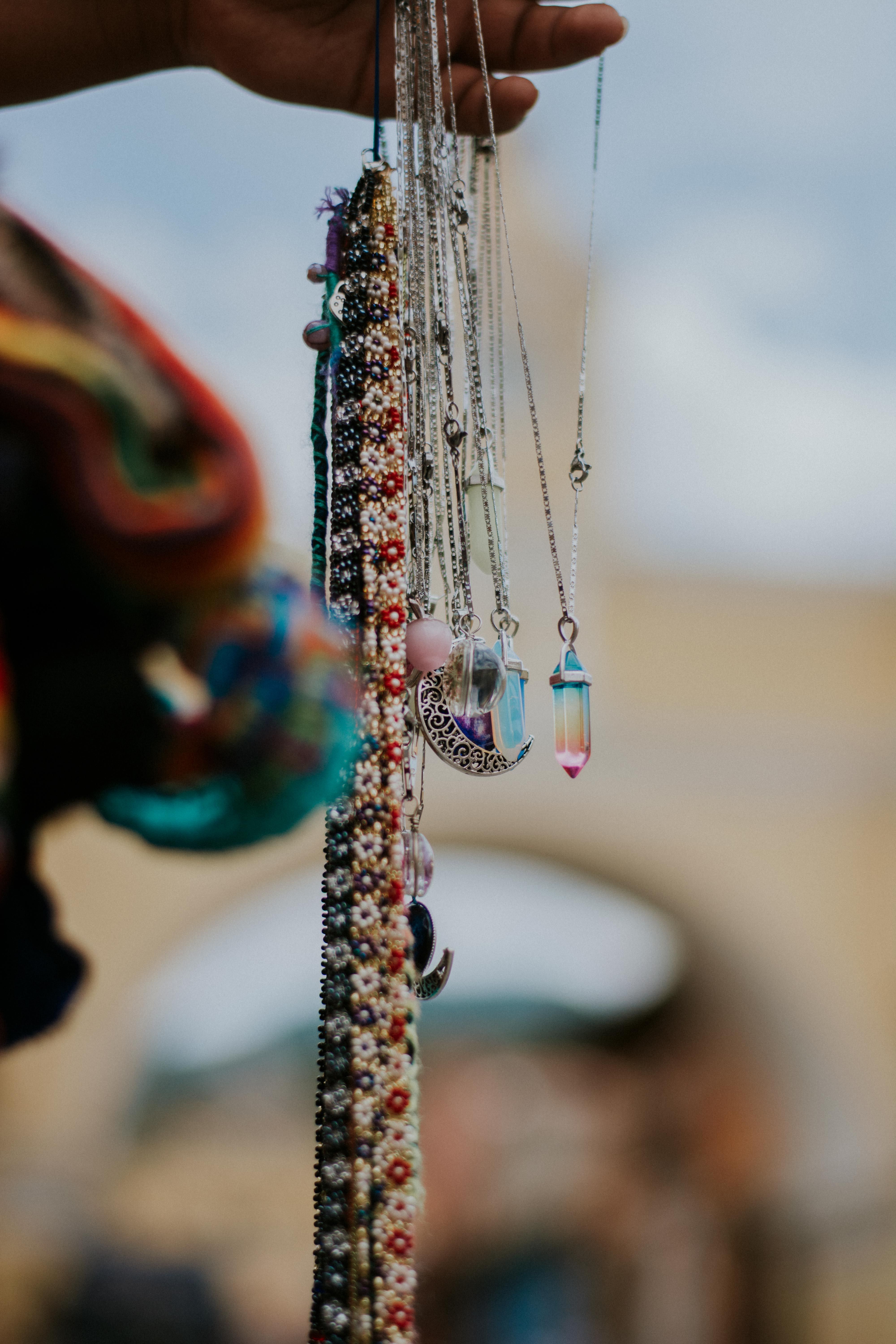 Close-up of Woman Holding a Bunch of Traditional Necklaces · Free Stock ...