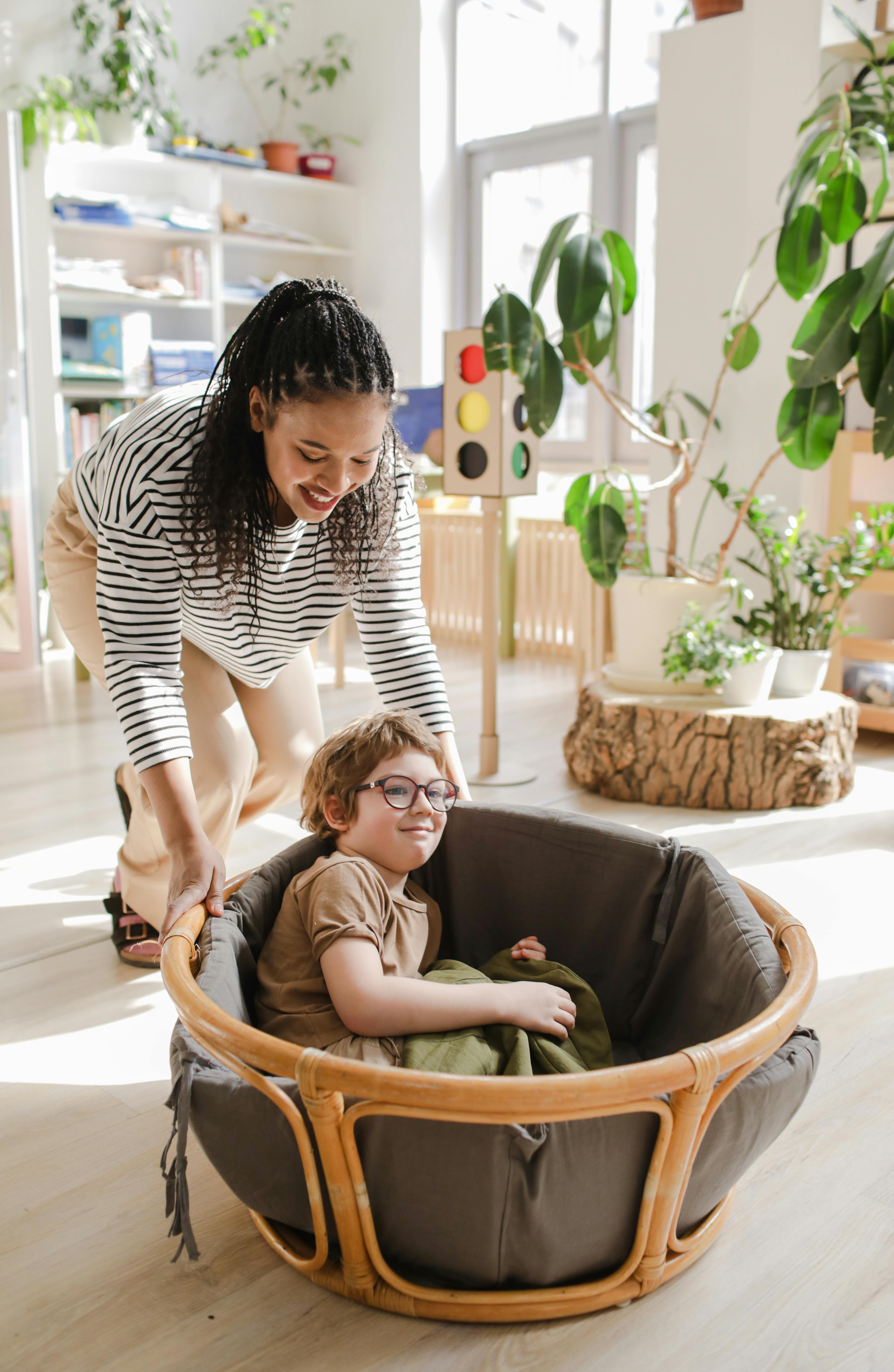 Woman Pushing Child In Basket In Childcare Photos, Download The BEST ...