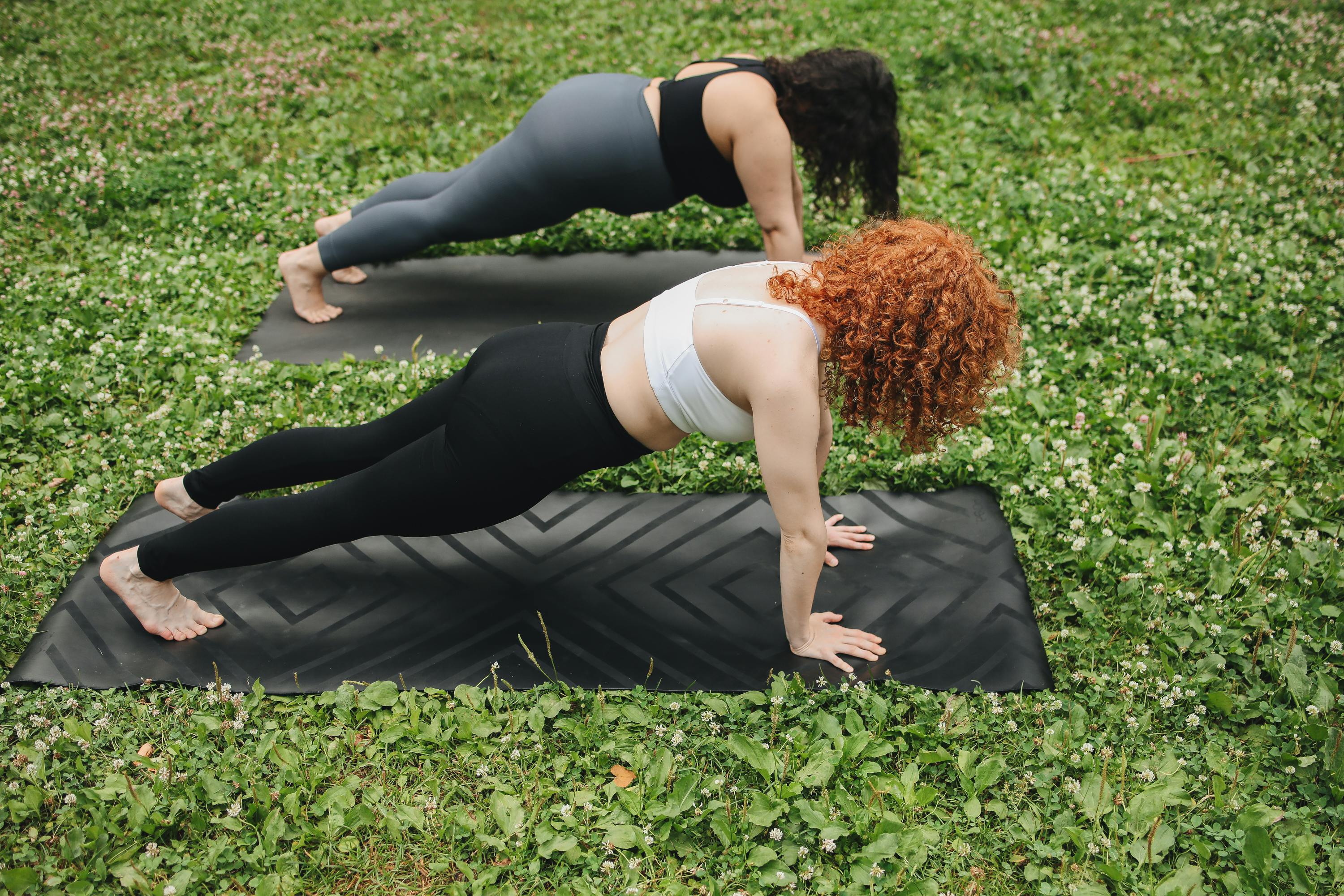 Photo of a Woman Doing Yoga on a Black Yoga Mat · Free Stock Photo