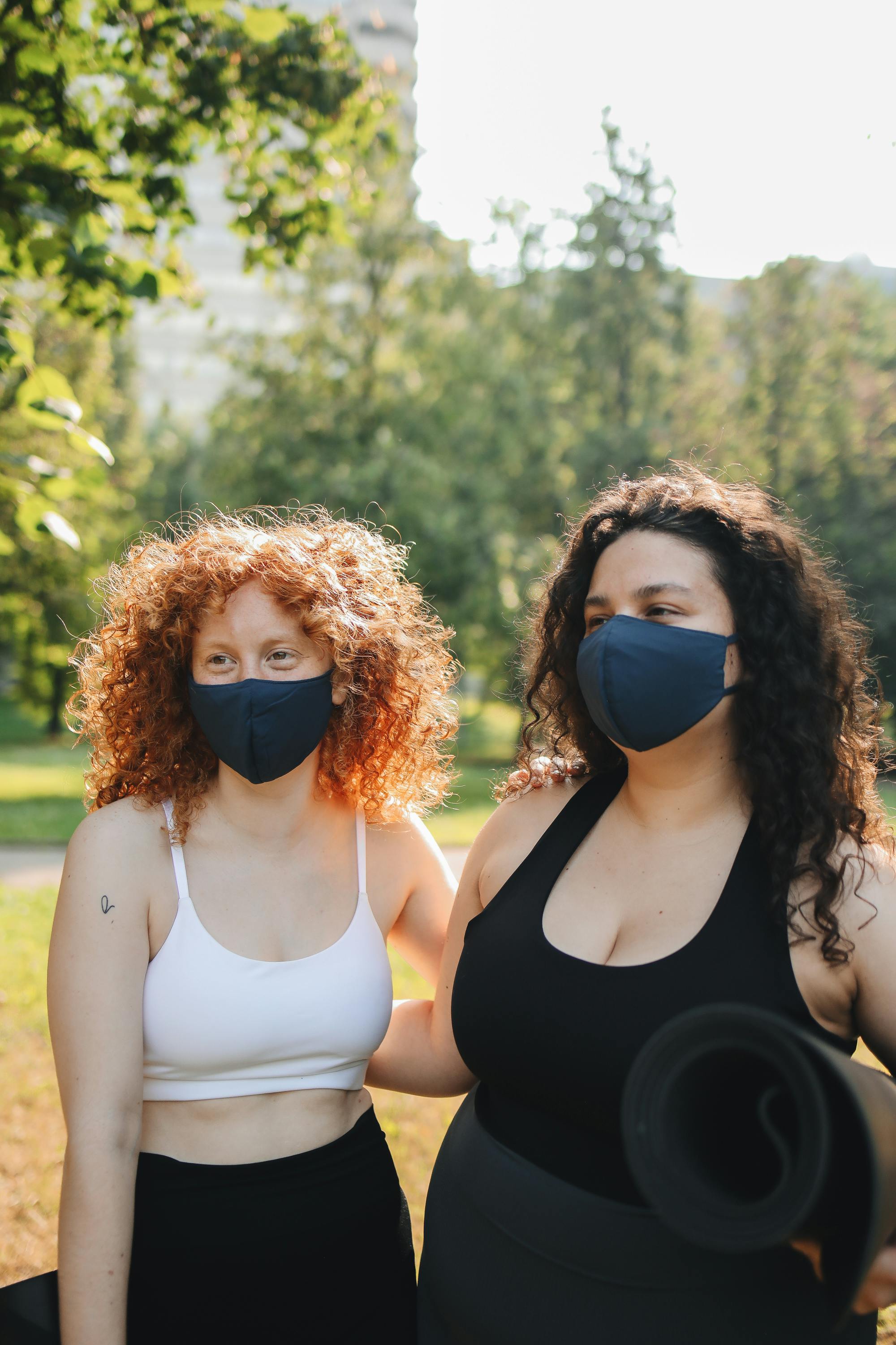 Close-Up Shot of Women in Sports Bra Wearing Face Masks · Free Stock Photo