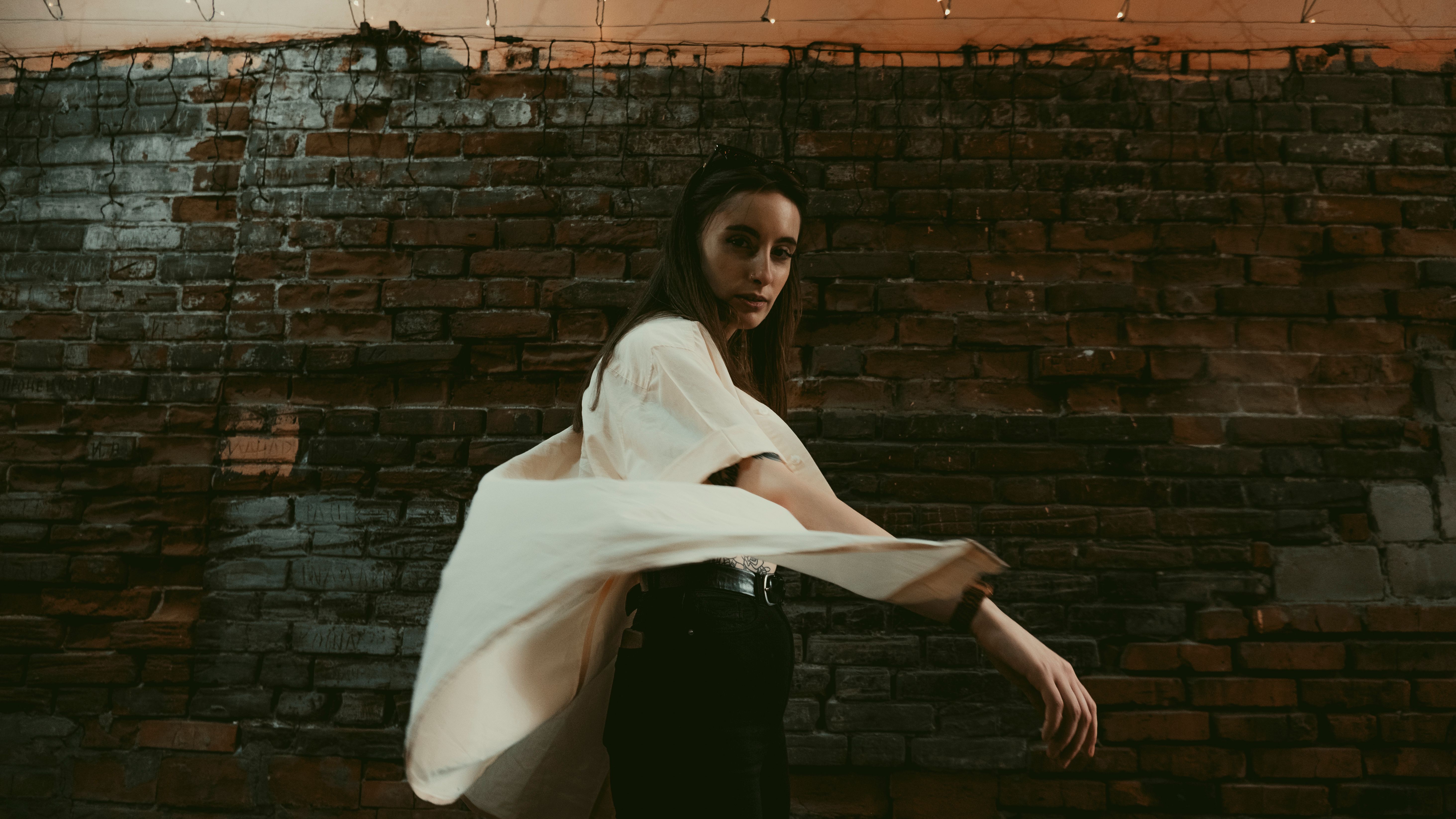 Woman Standing Near a Wall · Free Stock Photo
