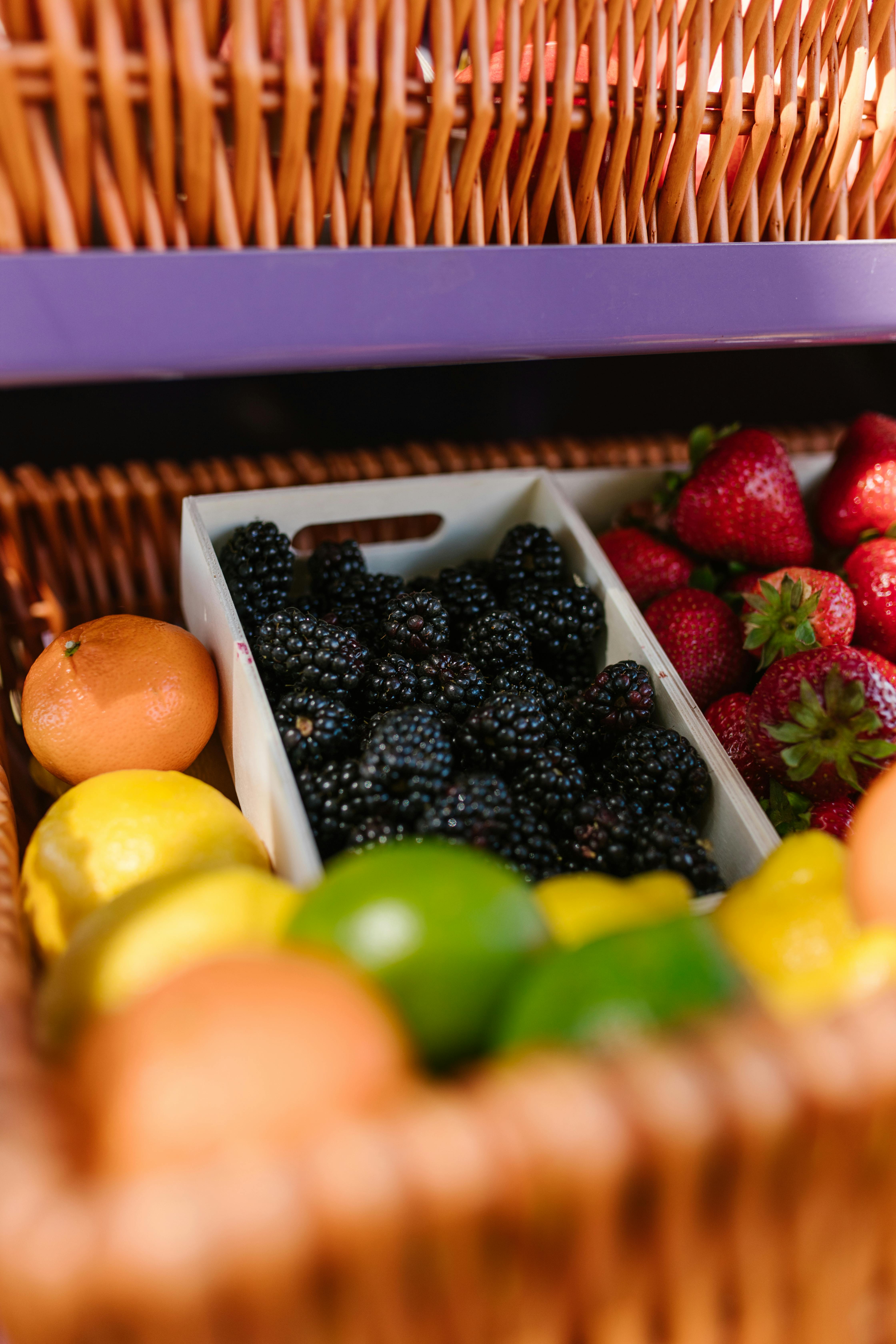 Fresh Fruits in Containers in Woven Basket · Free Stock Photo
