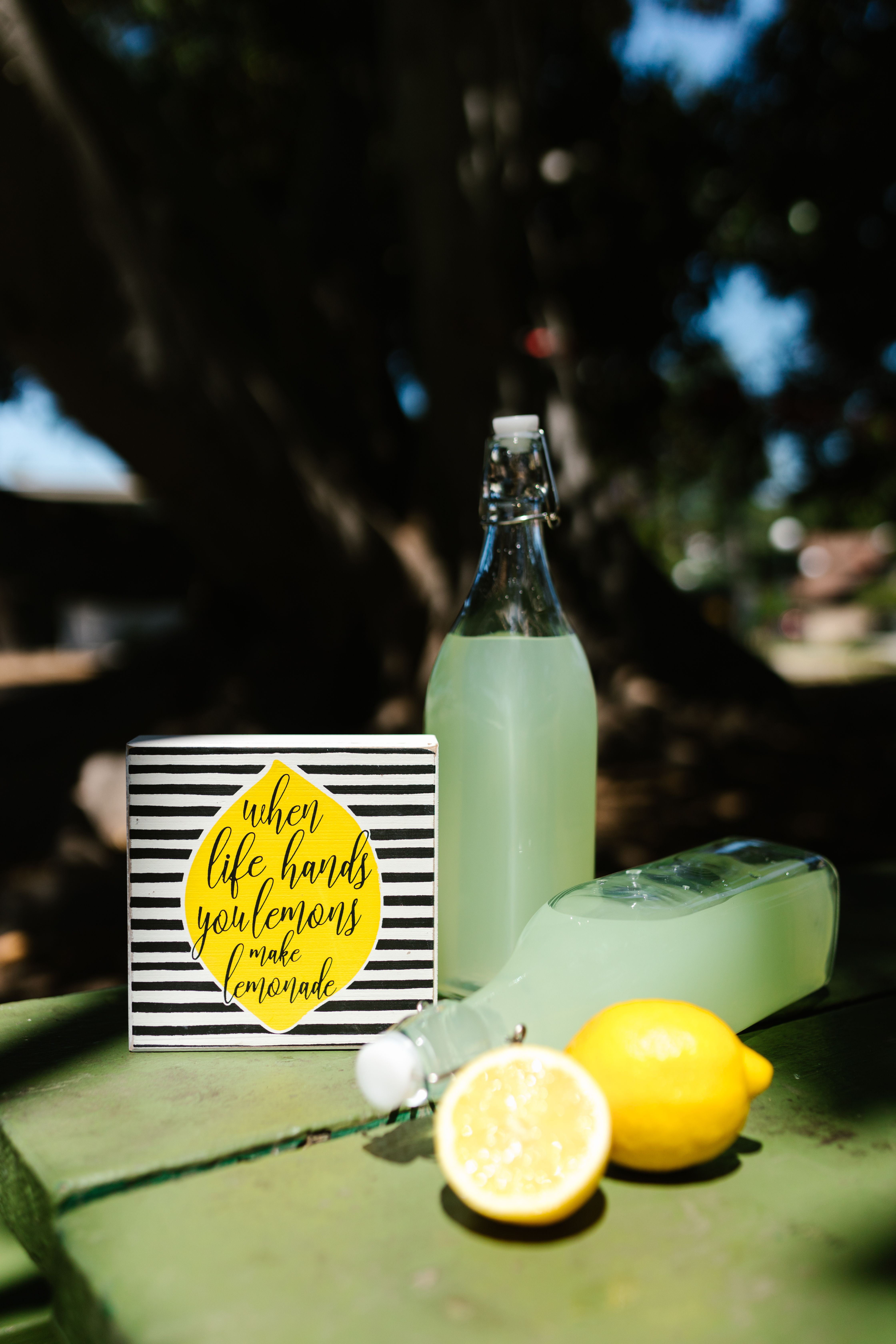 Slice Lemon Beside Glass Pitcher on Wooden Table · Free Stock Photo