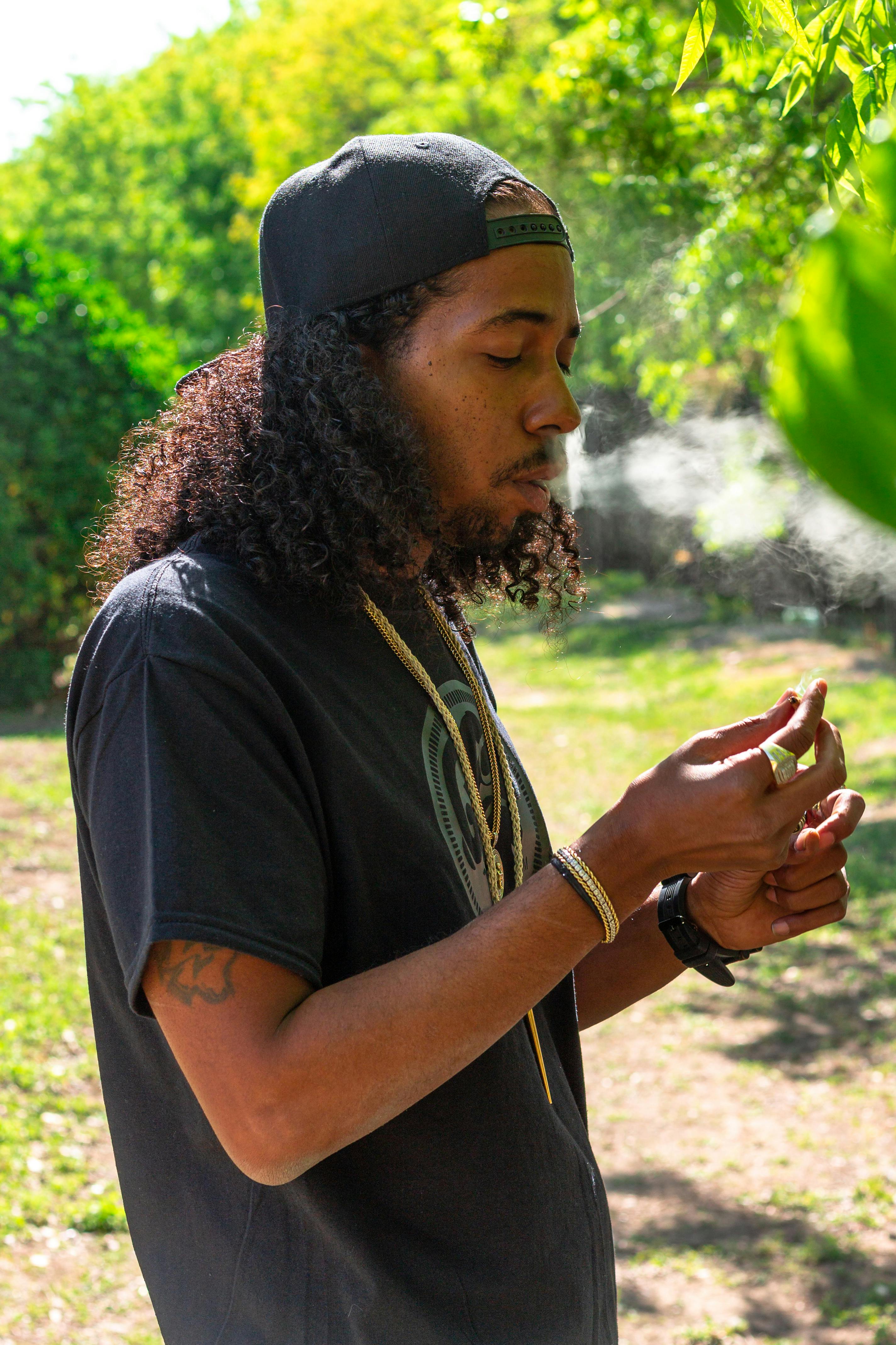 A Man wearing Cap Looking his Hand · Free Stock Photo
