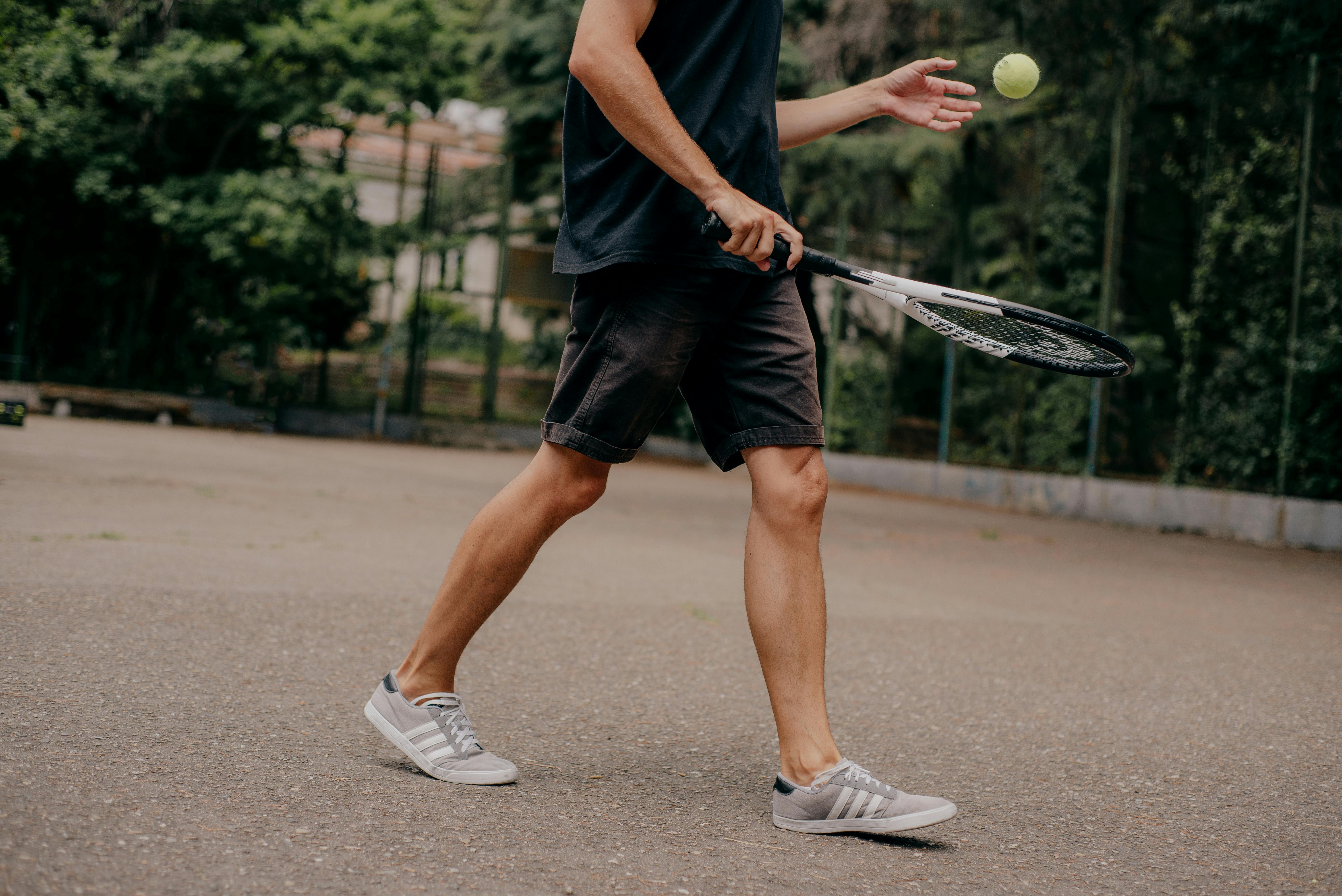 Person holding Tennis Racket and Ball · Free Stock Photo