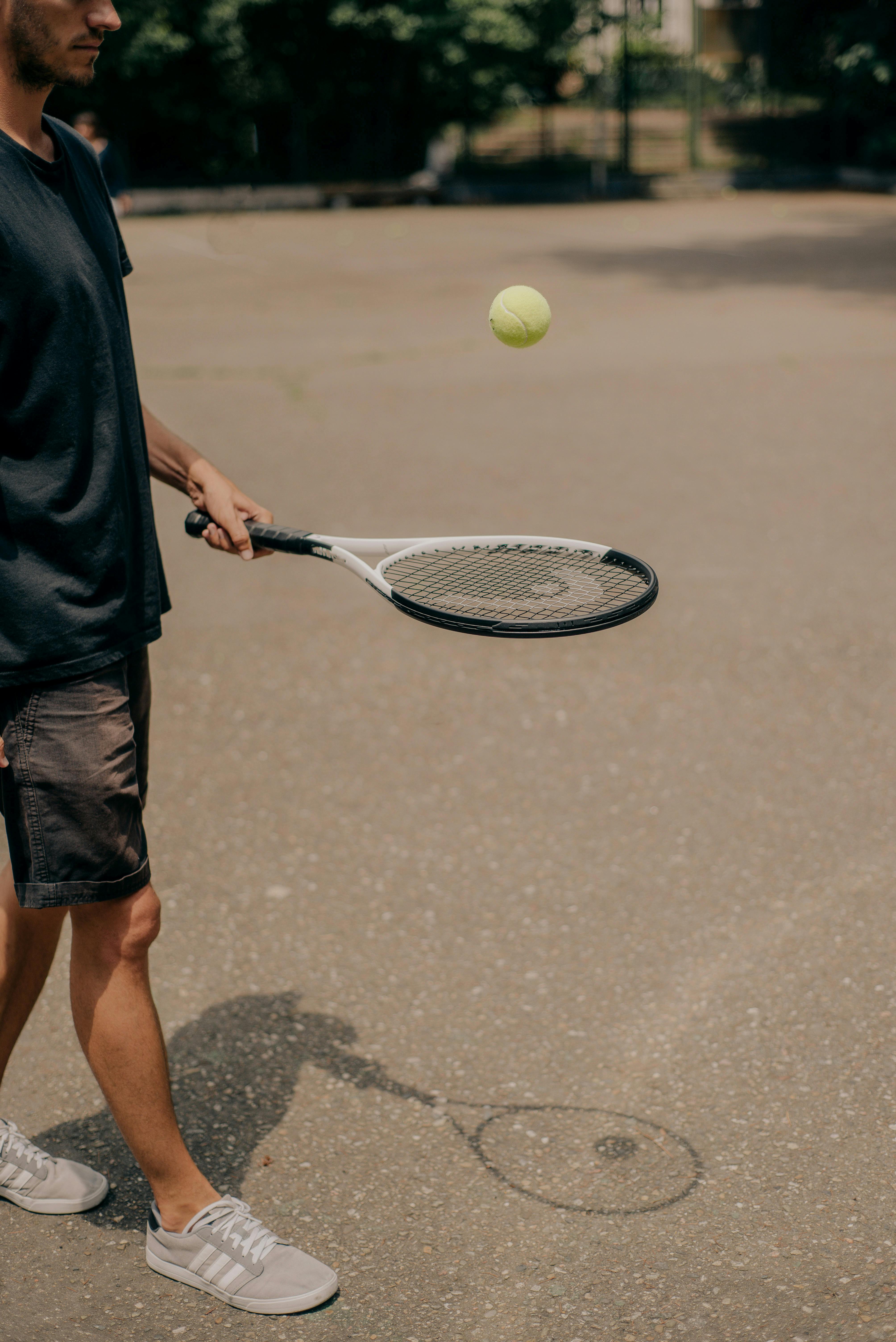 A Man Playing a Tennis Racket and Tennis Ball · Free Stock Photo
