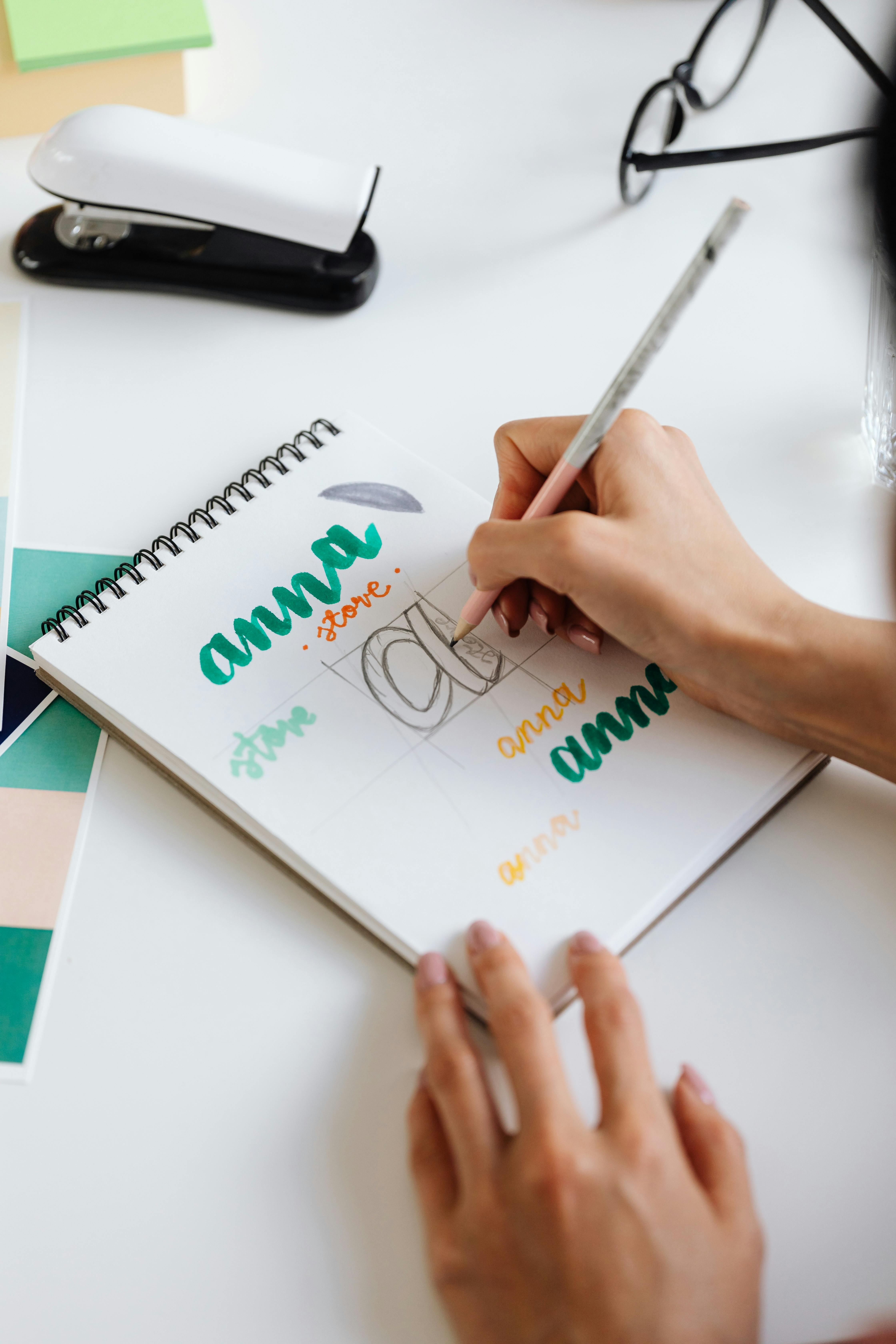 Hand Drawing on a Notebook · Free Stock Photo