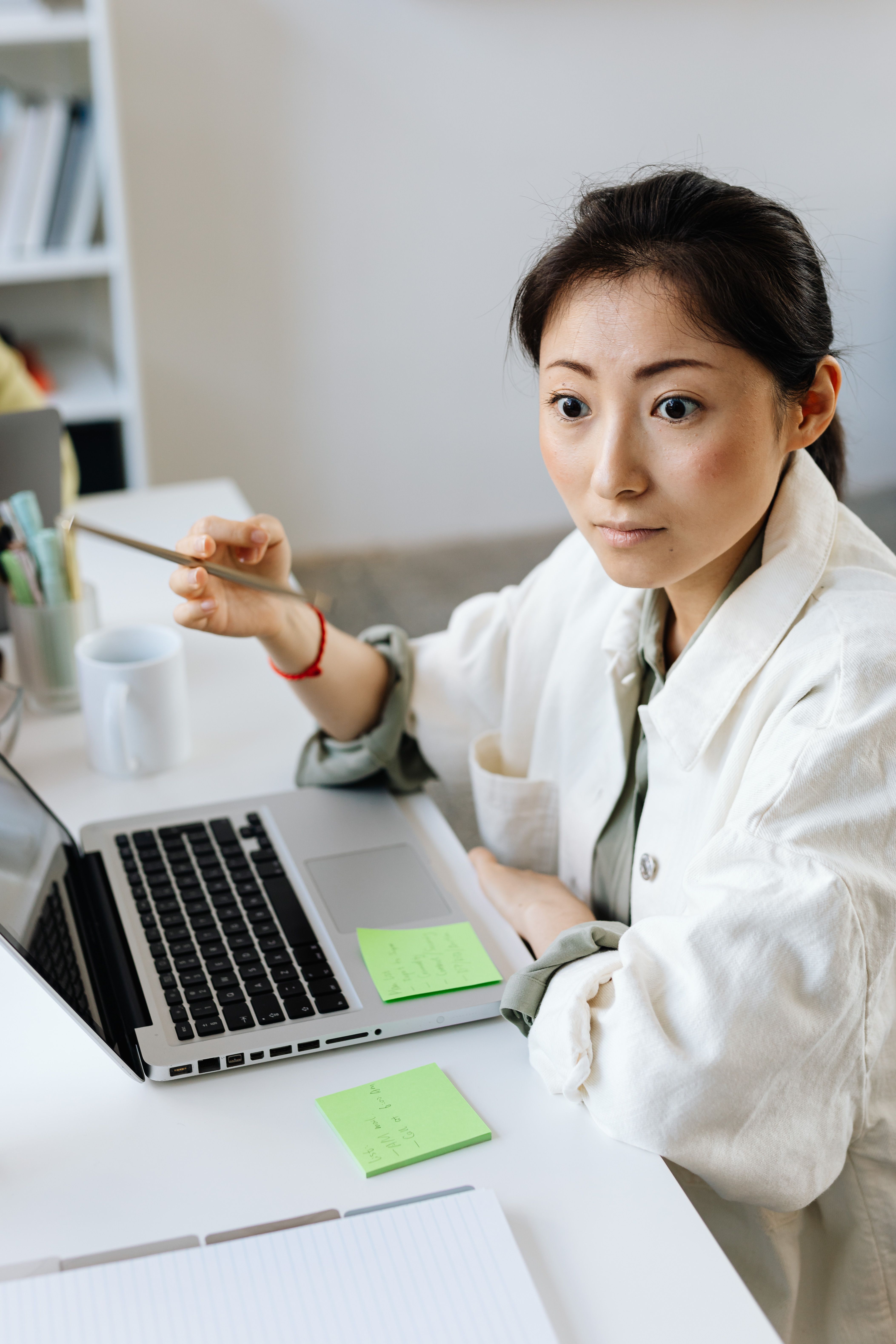 Shocked Woman Holding a Pen · Free Stock Photo