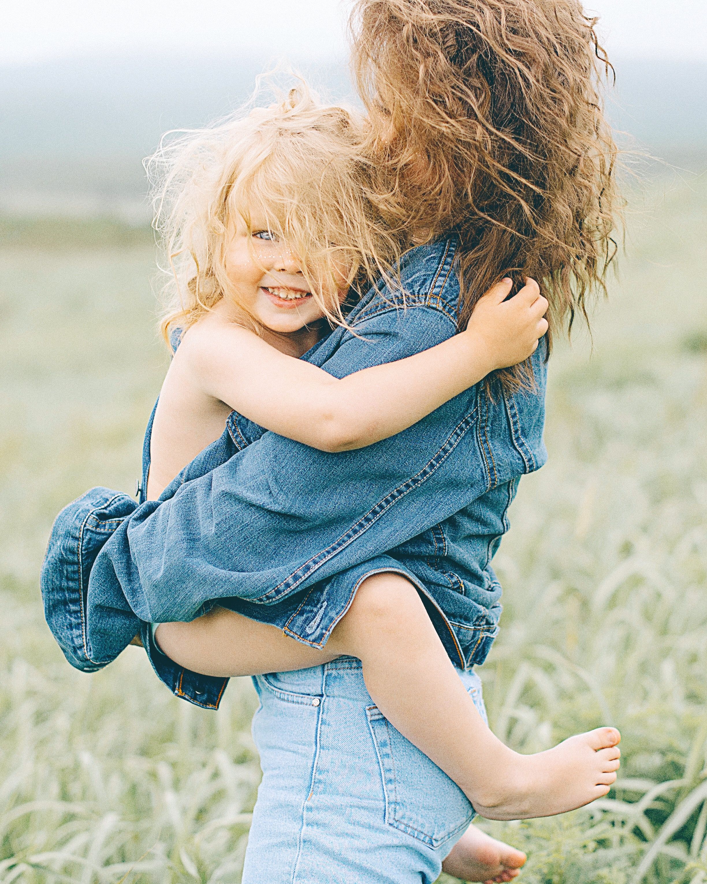 A Young Girl Carrying a Brown Dog · Free Stock Photo